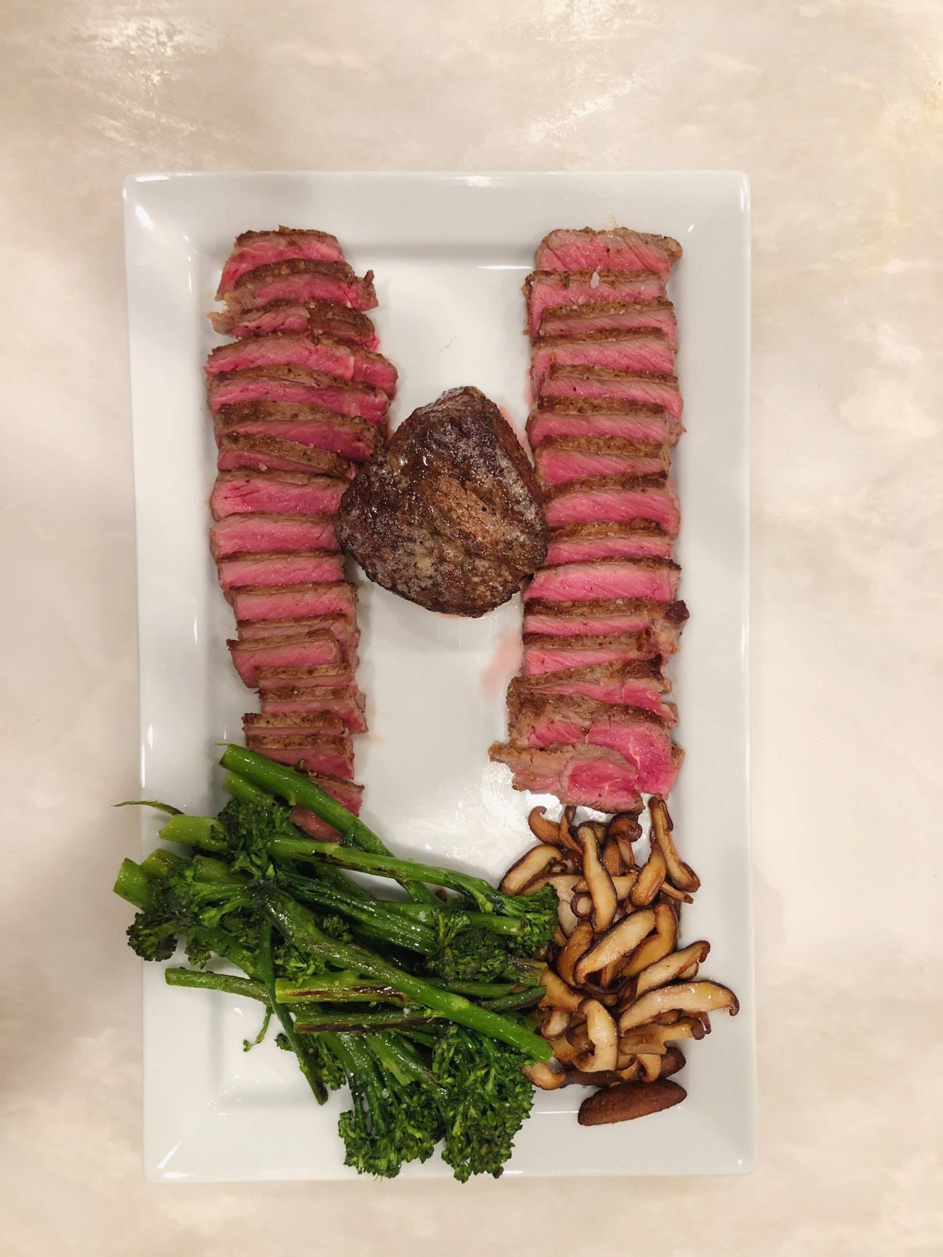 Pan-seared NY strips and bison filet, blanched and sautéed broccolini ...