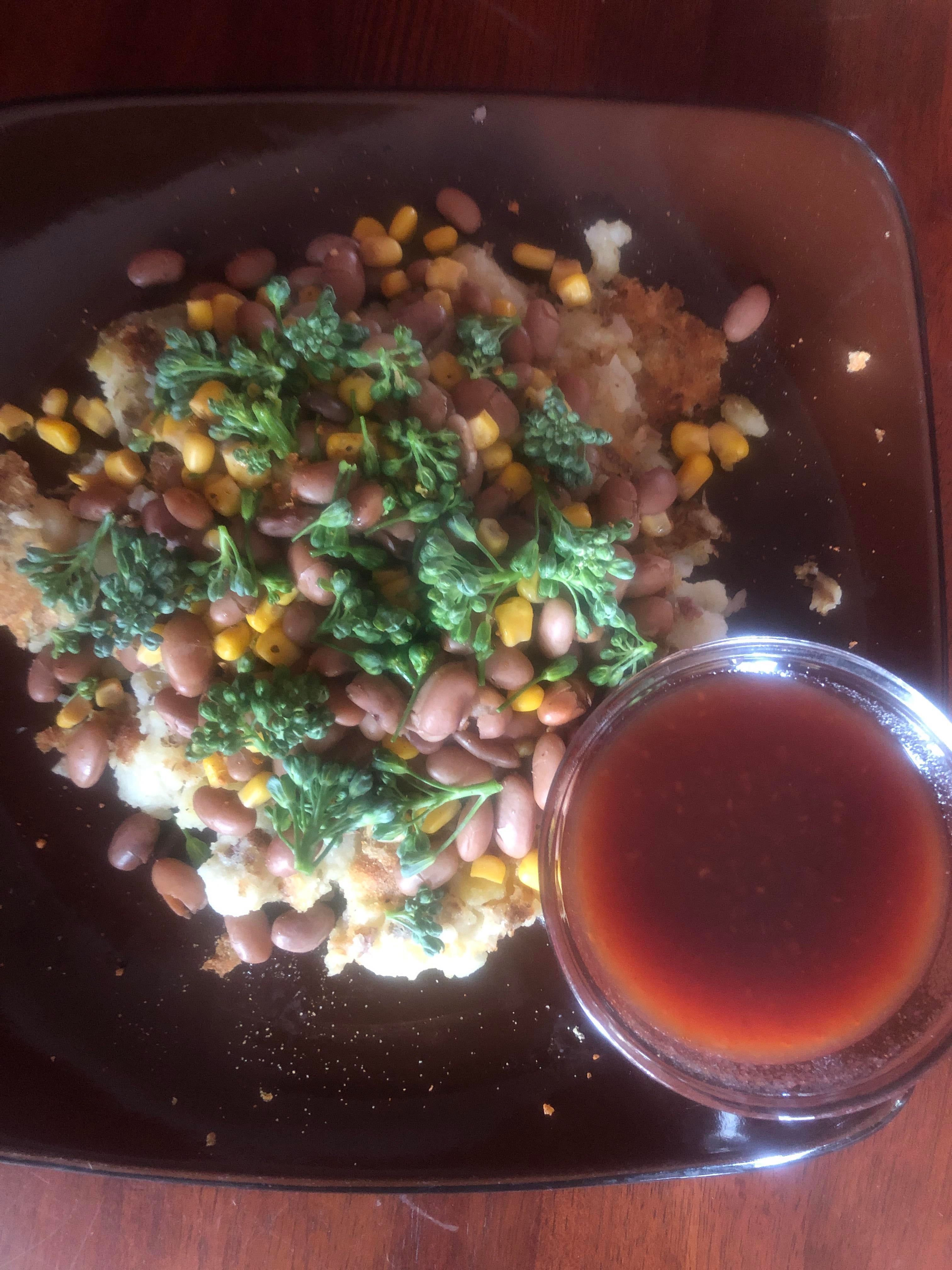 Pinto beans, corn, and broccoli on a potato pancake with a spicy ...