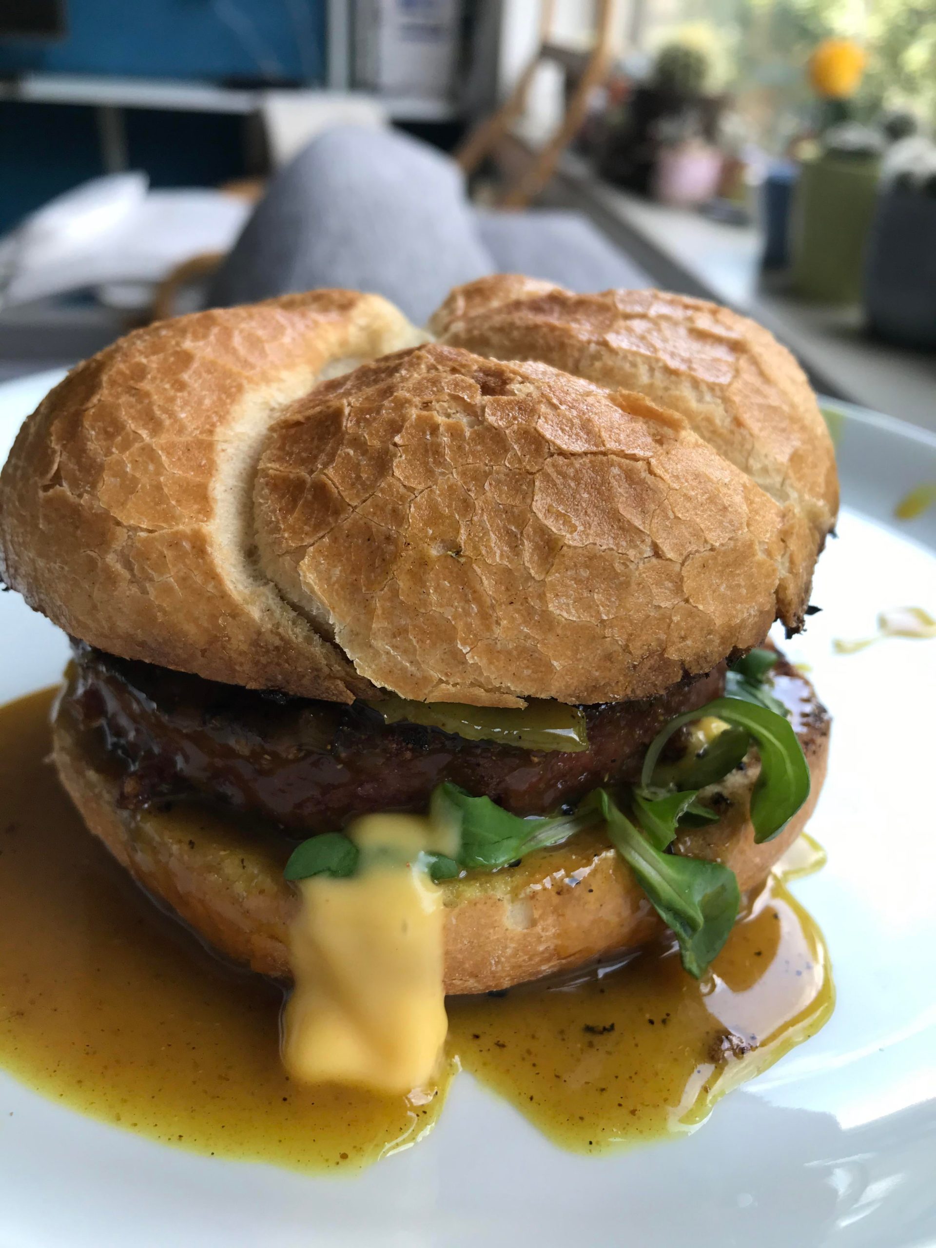 Beyond Beef, cheez, coconut curry cooked onions, lettuce on a kaiser ...