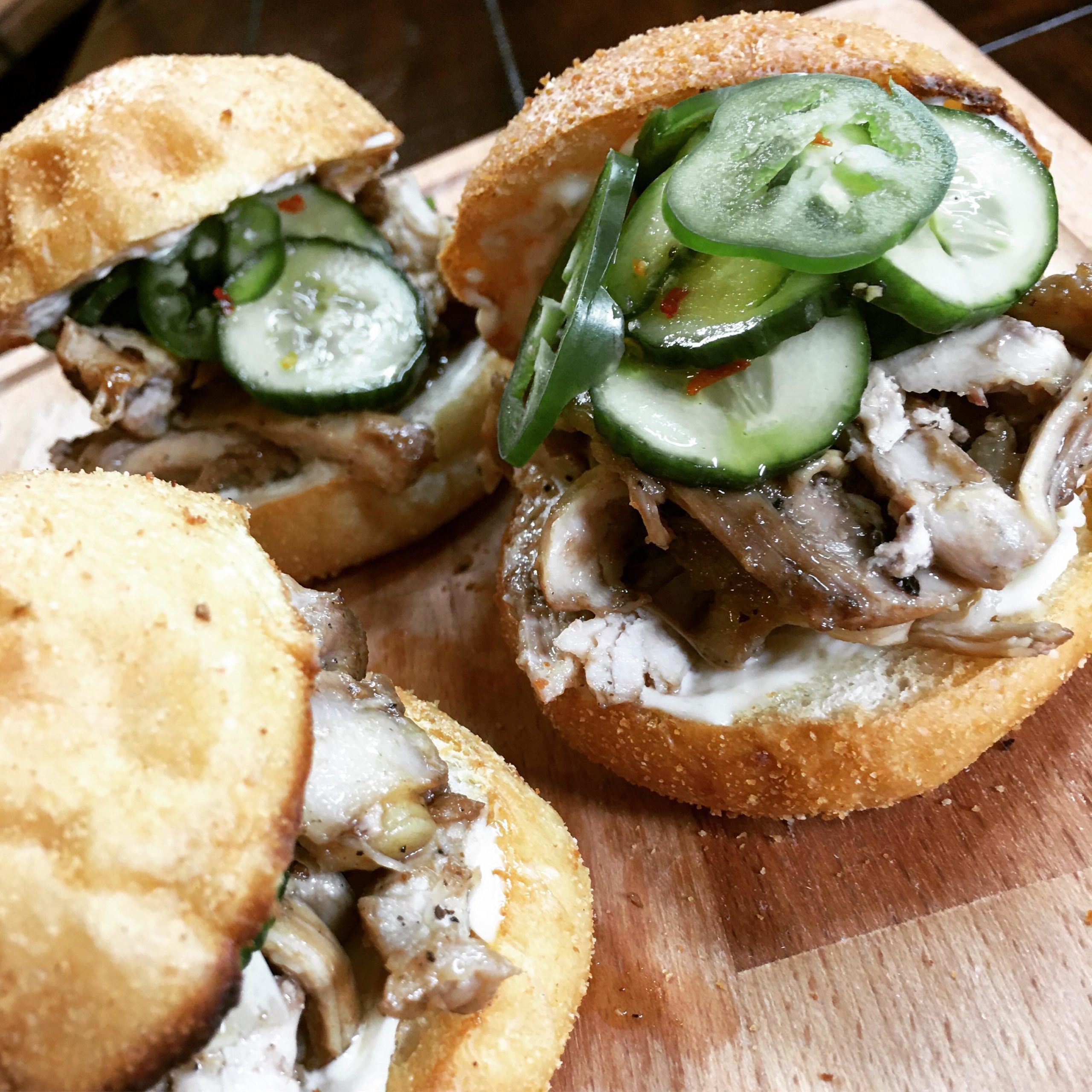 Chicken adobo with fresh chilled pickles on warm toasted pandesal is a ...