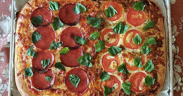 I made a split pizza: marinara with pepperoni and pesto with thin ...