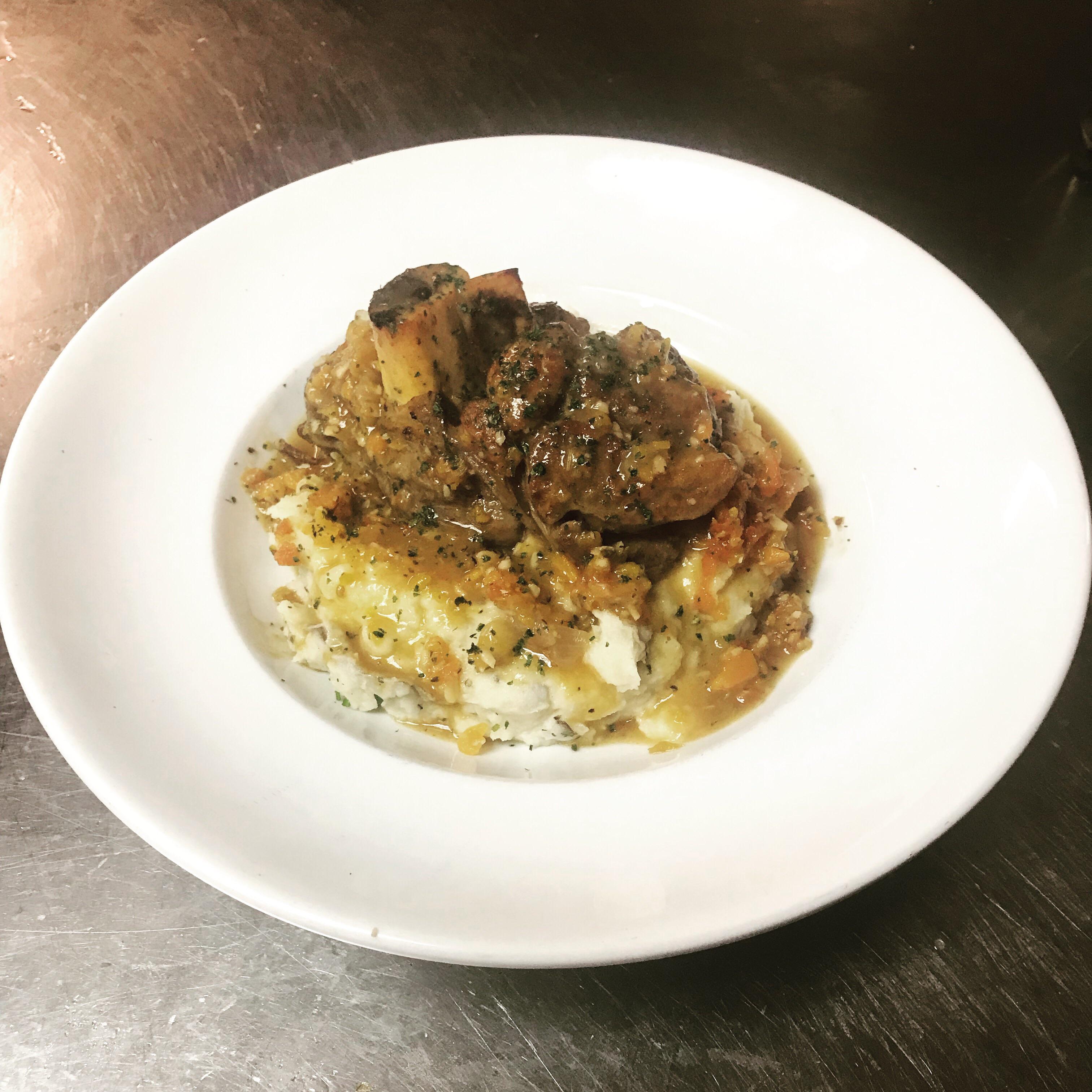 Ossobuco; braised veal shank with garlic mash topped with a pan sauce ...