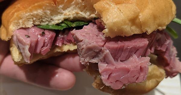 Homemade corned beef on a Hawaiian bun with a bit of mayo, mustard, and ...