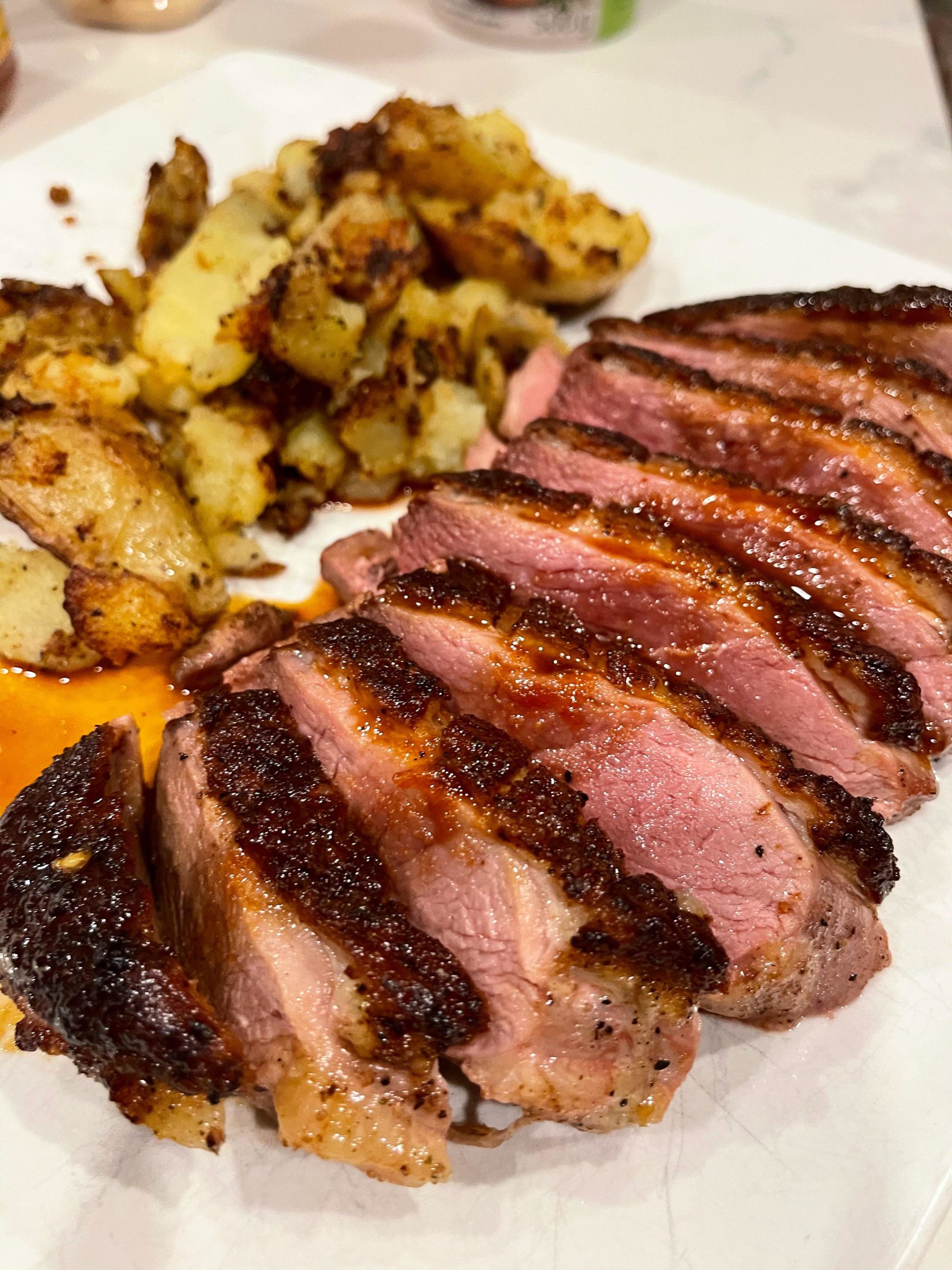 Duck steak (Magret) cooked in the cast iron with duck fat fried smashed ...