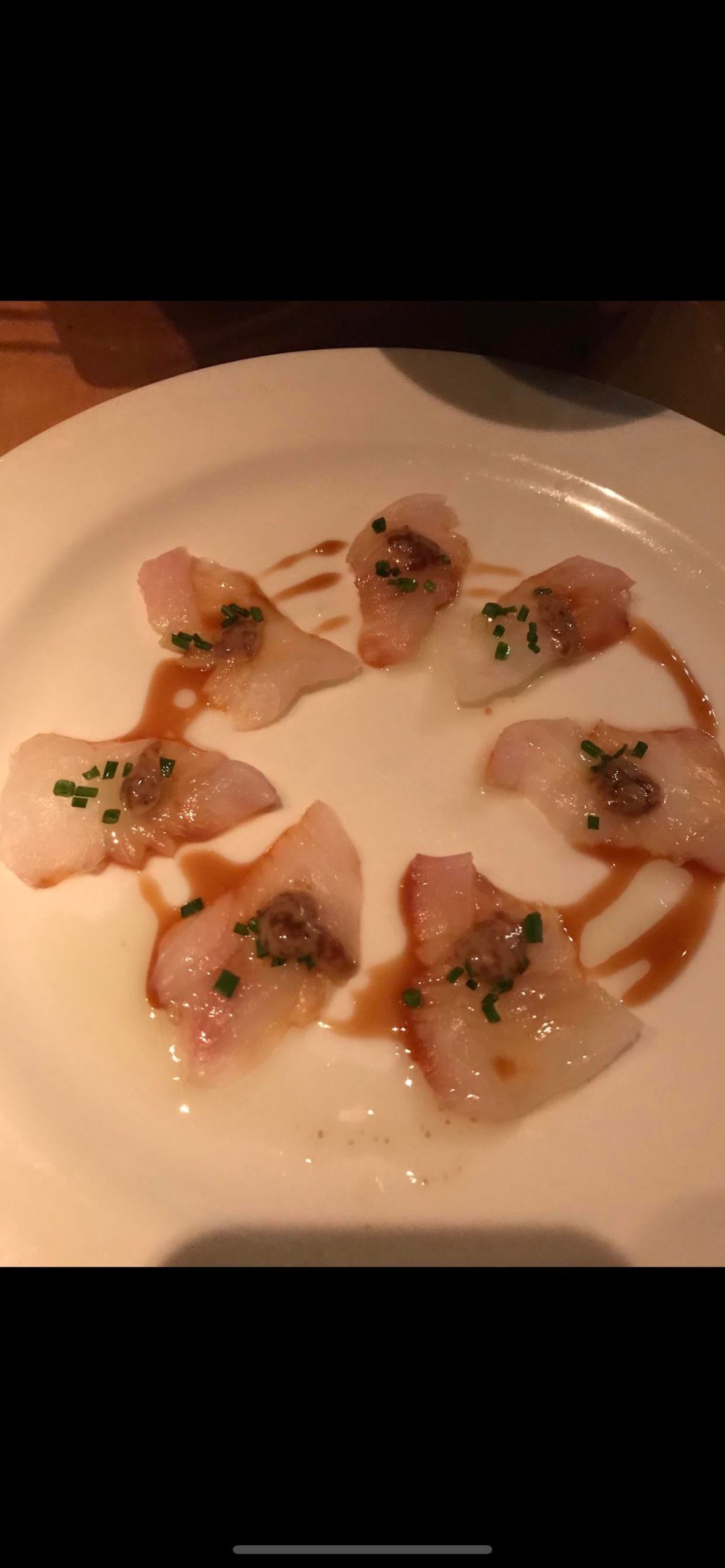 Red snapper sashimi with ponzu and dollop of black truffle purée ...