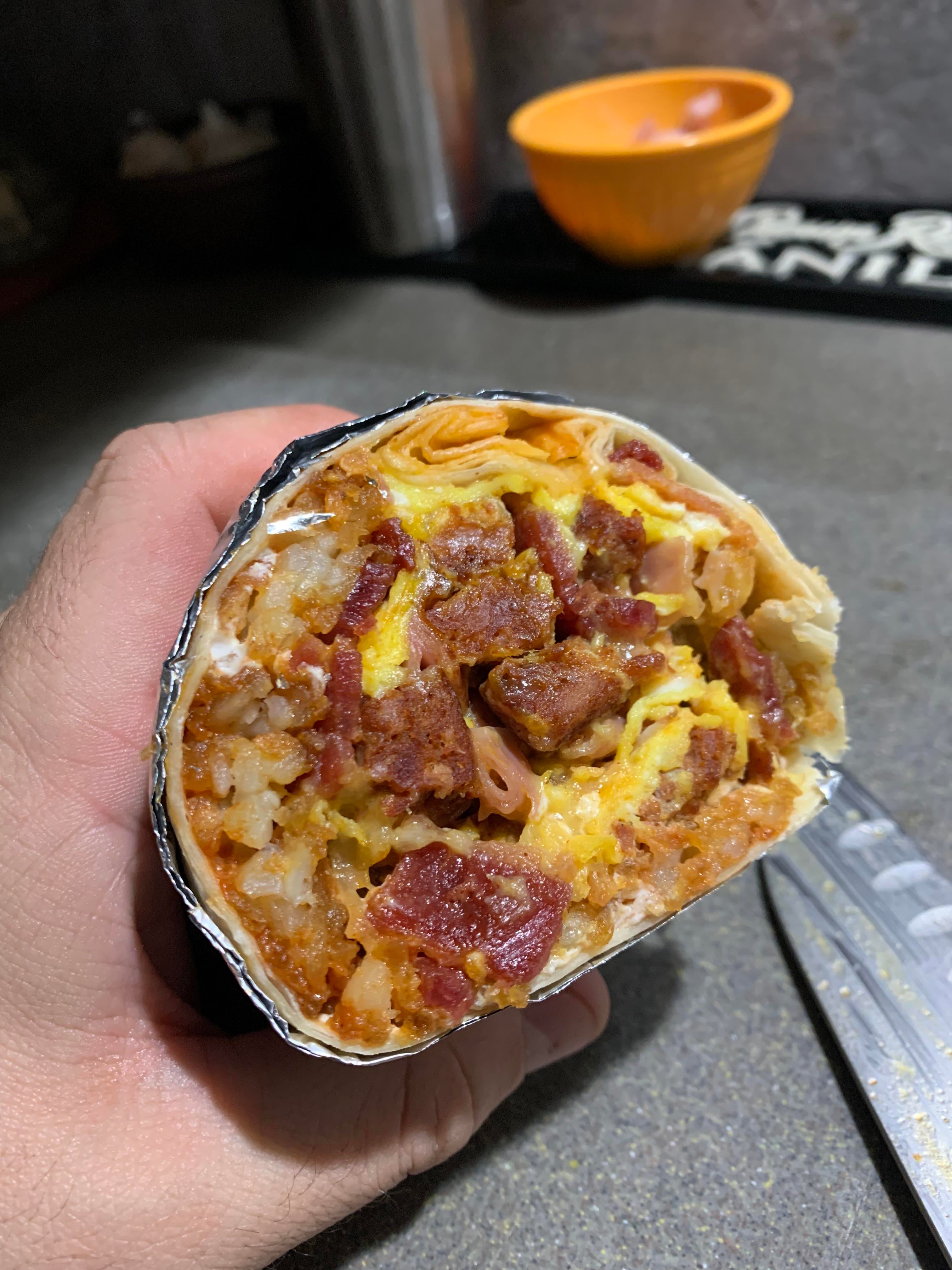 Homemade Chorizo, ham and bacon breakfast burrito with hash browns ...
