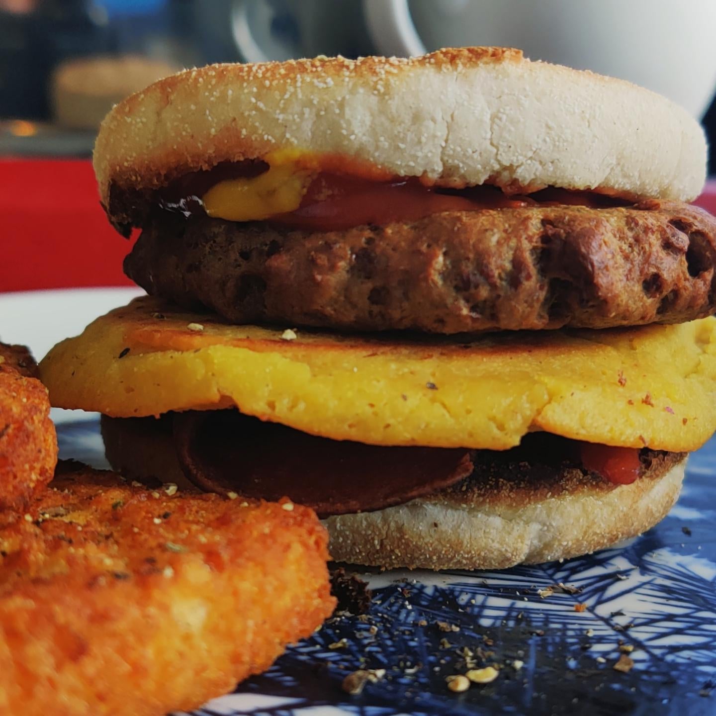 Breakfast muffin with bacon style rashers, vegan egg and plant based ...