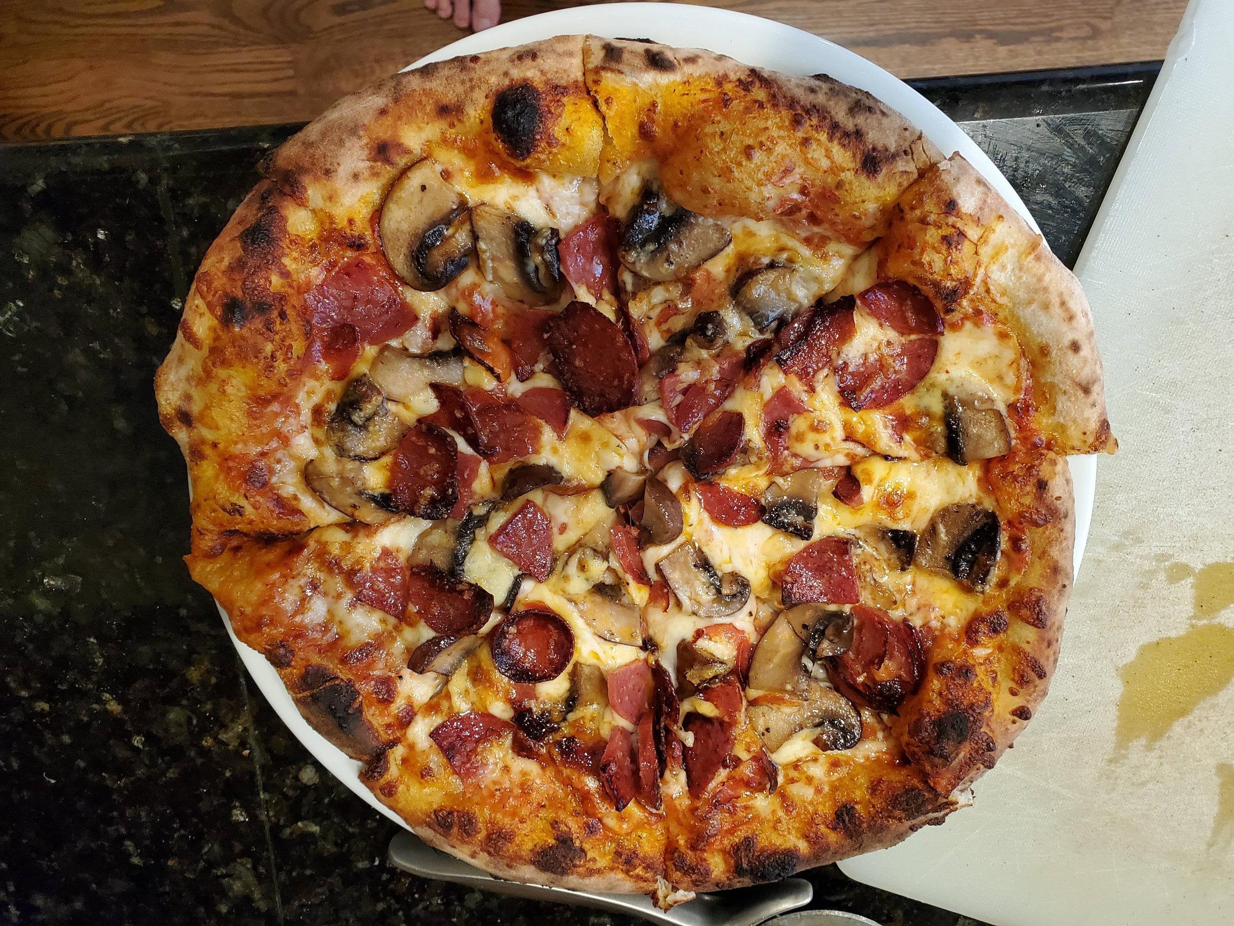 Spicy salami, pepperoni, crimini mushrooms, Gouda, from the ooni ...