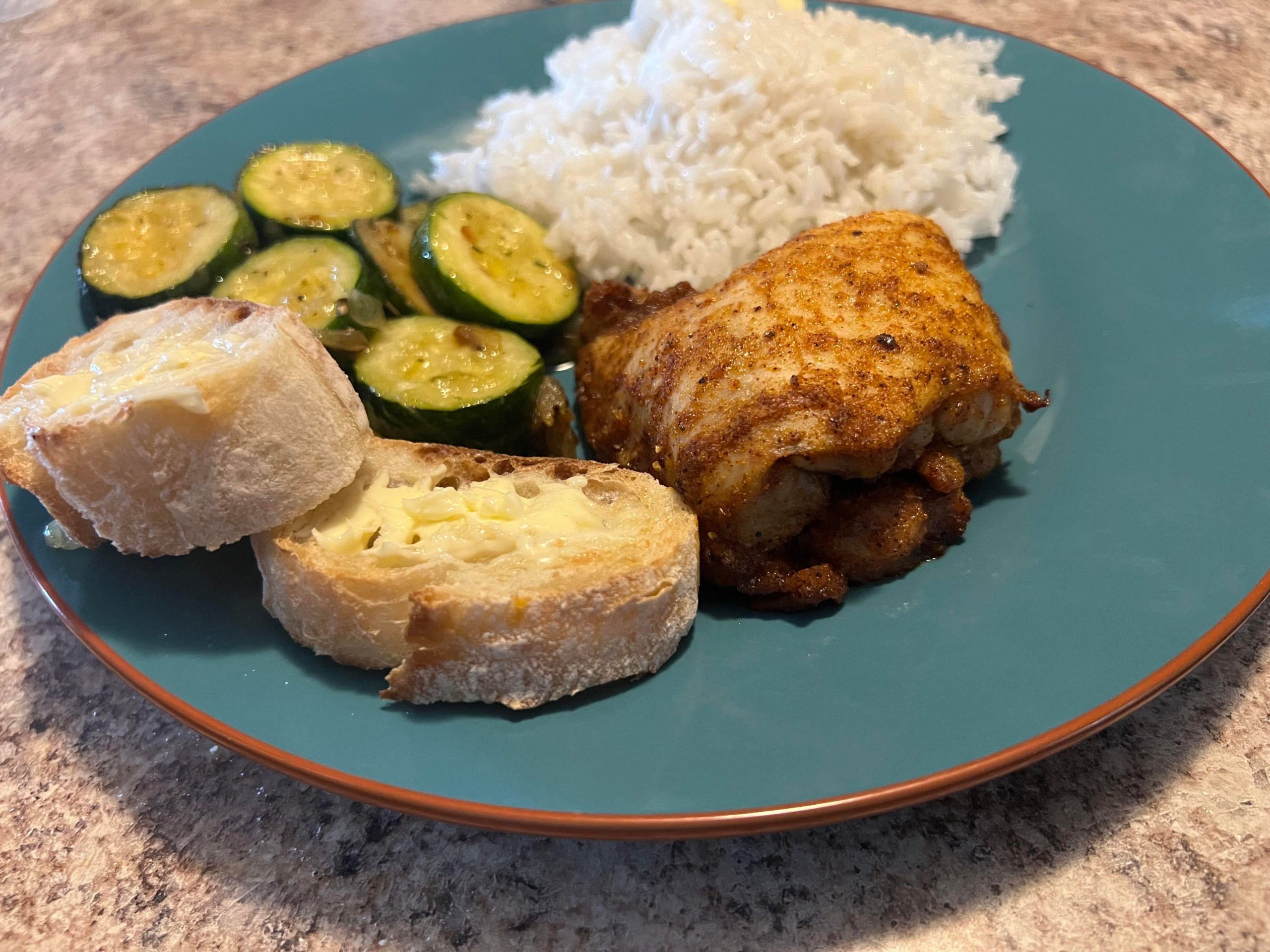 Baked chicken thighs , rice , zucchini , onion and crusty bread ...