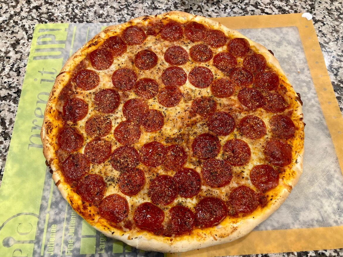 Homemade pepperoni pizza. A dusting of cornmeal on the bottom is a game ...
