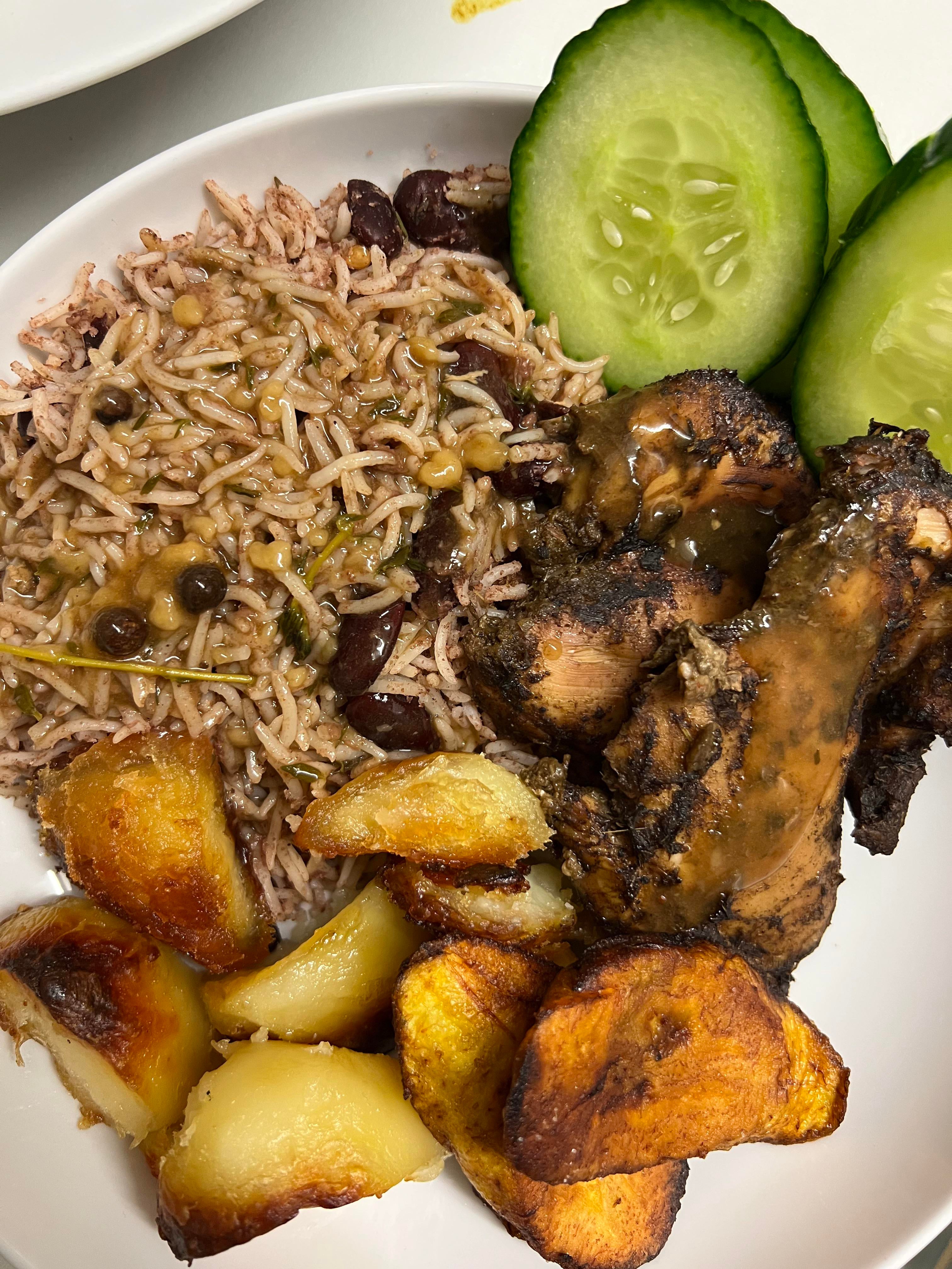 Jerk Chicken, rice and peas, plantain, roast potatoes and cucumber ...