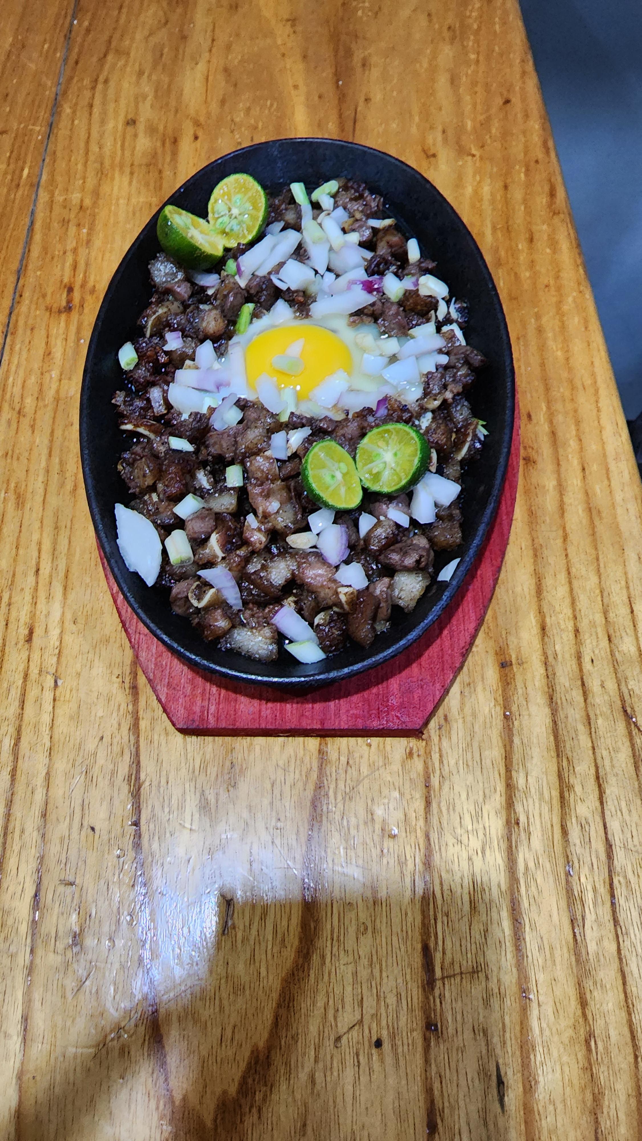 Sizzling Sisig, a filipino speciality. You can almost hear the crispy ...