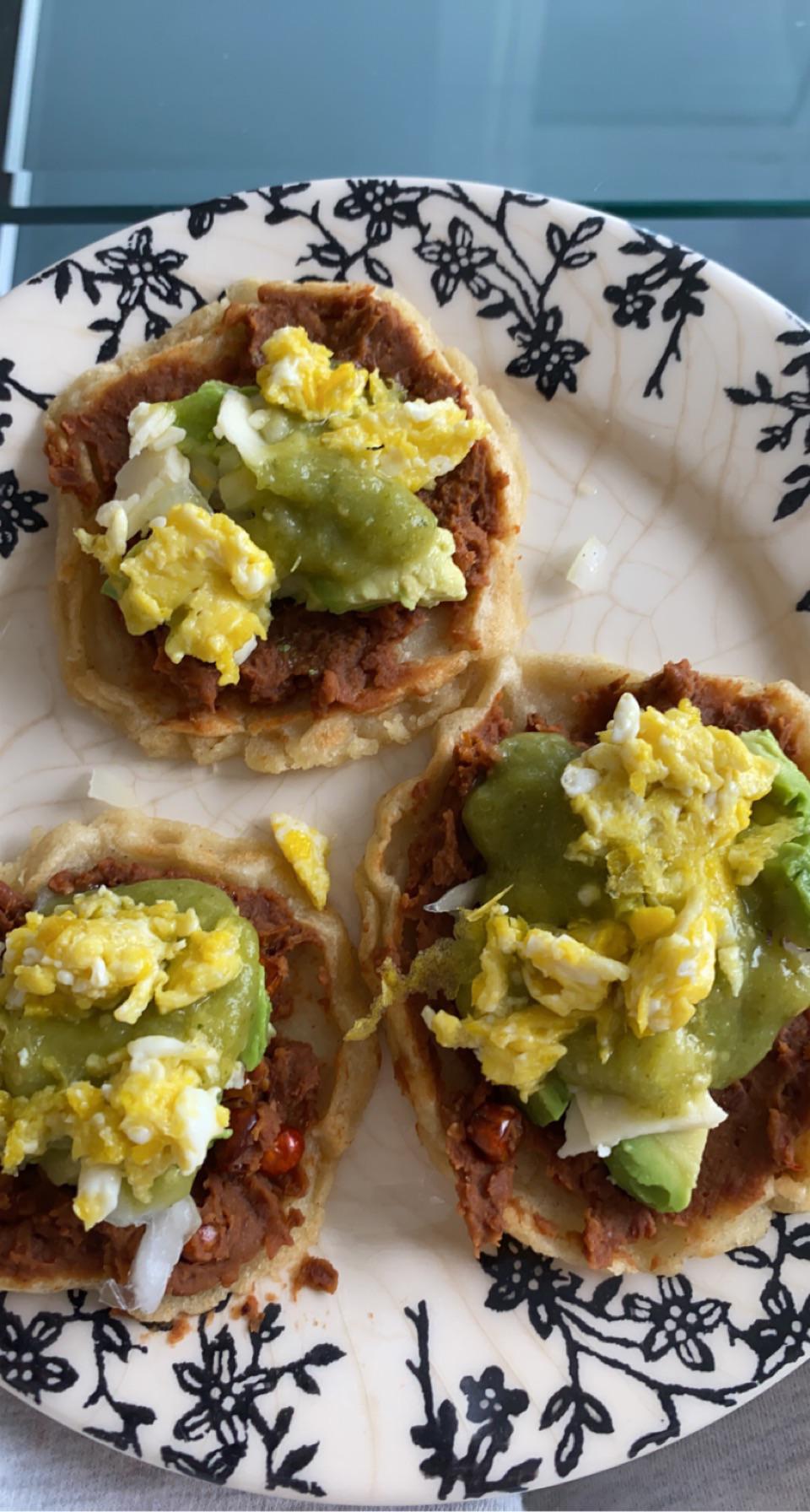 Sopesitos with frijoles, salsa verde, eggs, cheese, and onions ...