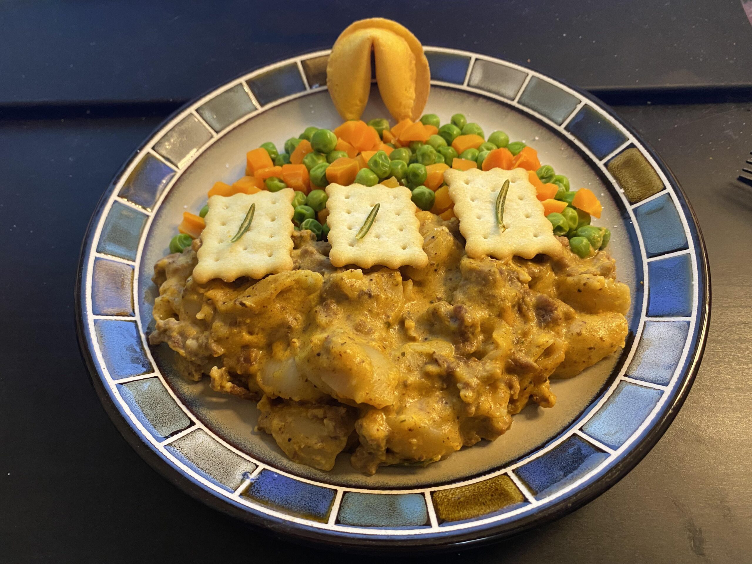 Hamburger Helper, garnished with chicken crackers. Served with ...