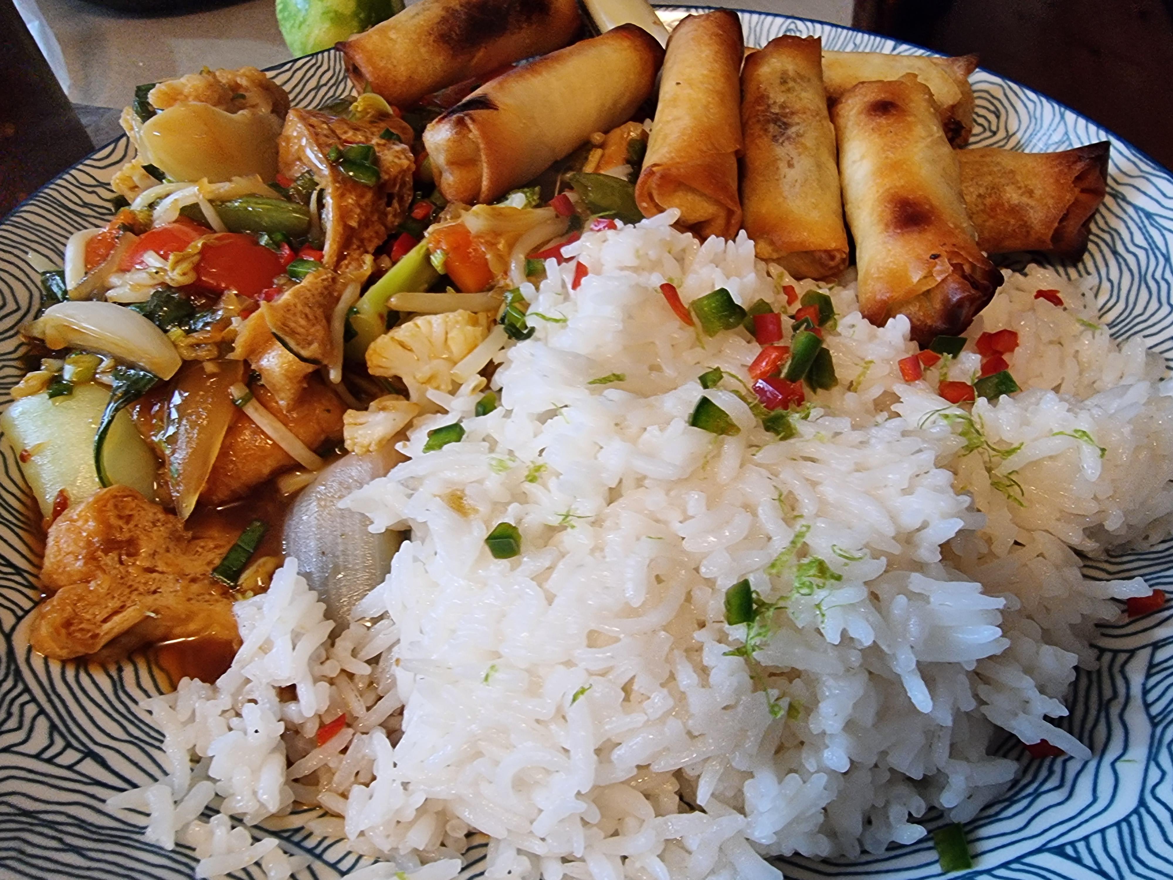 Vegan pad gra pao with coconut rice and spring rolls