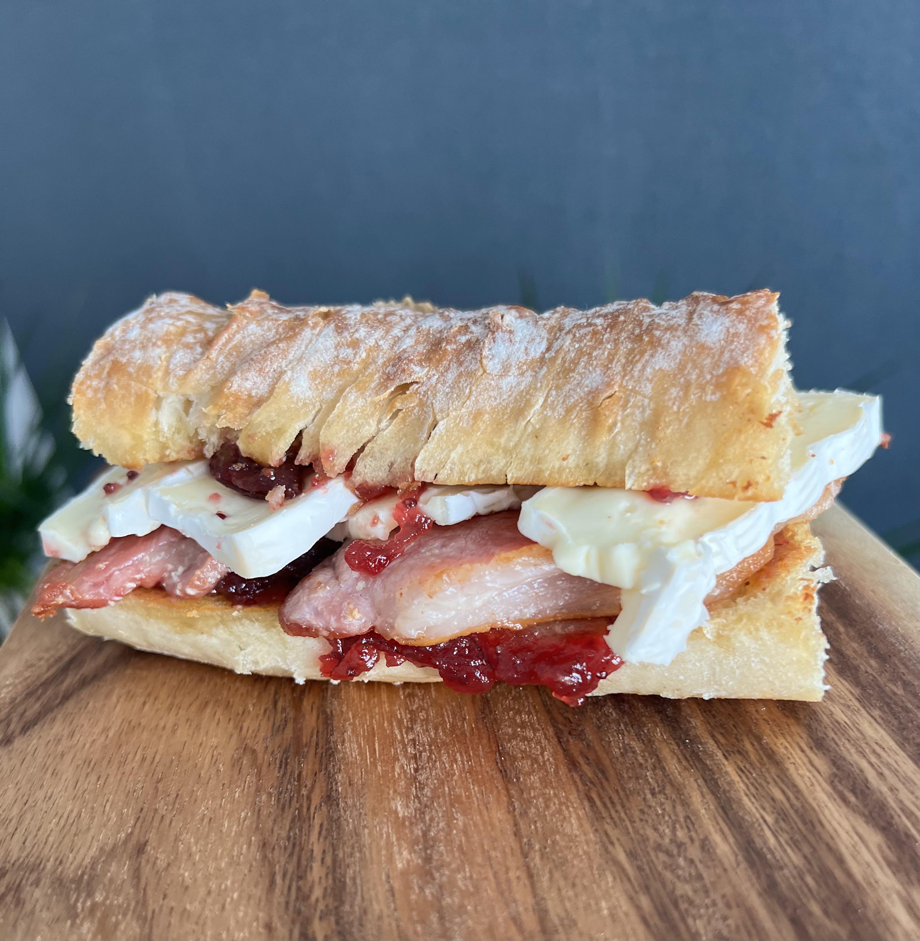 Bacon, brie and cranberry on sourdough baguette. Bread was toasted in ...