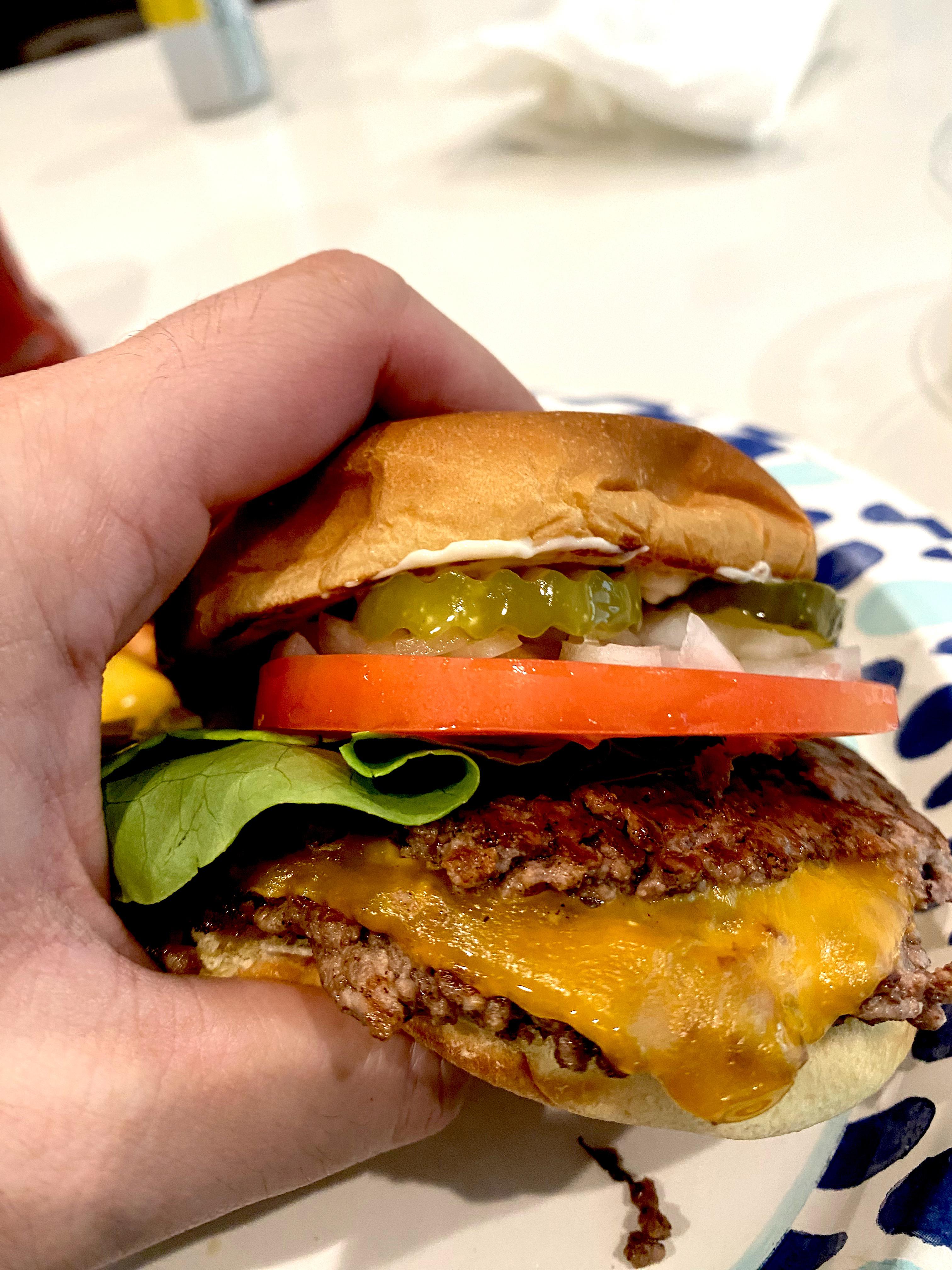 Double smash burger with sharp cheddar cheese and traditional toppings ...