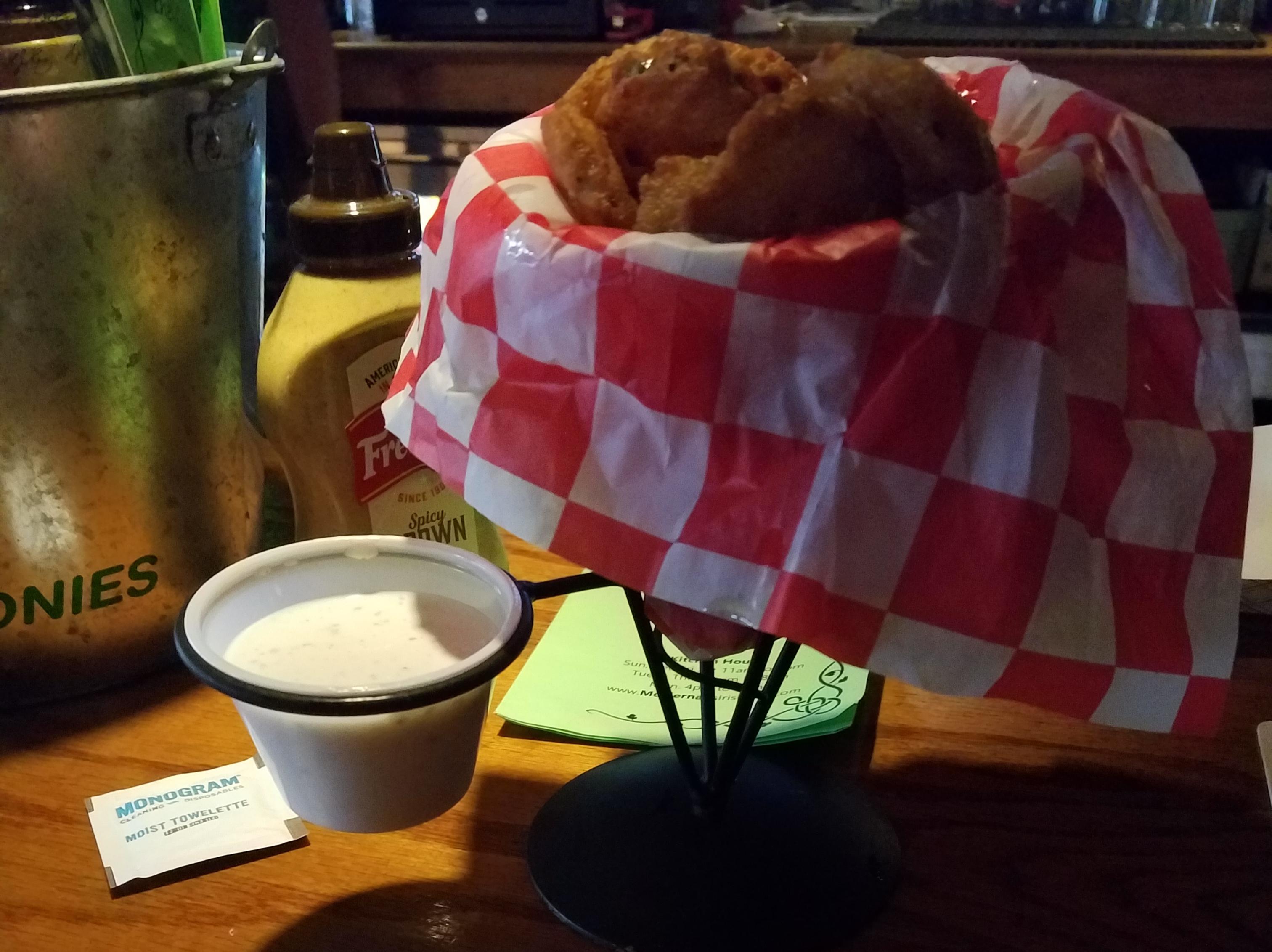 Pickle Chips served in a wire cone with a wire ring that holds small ...
