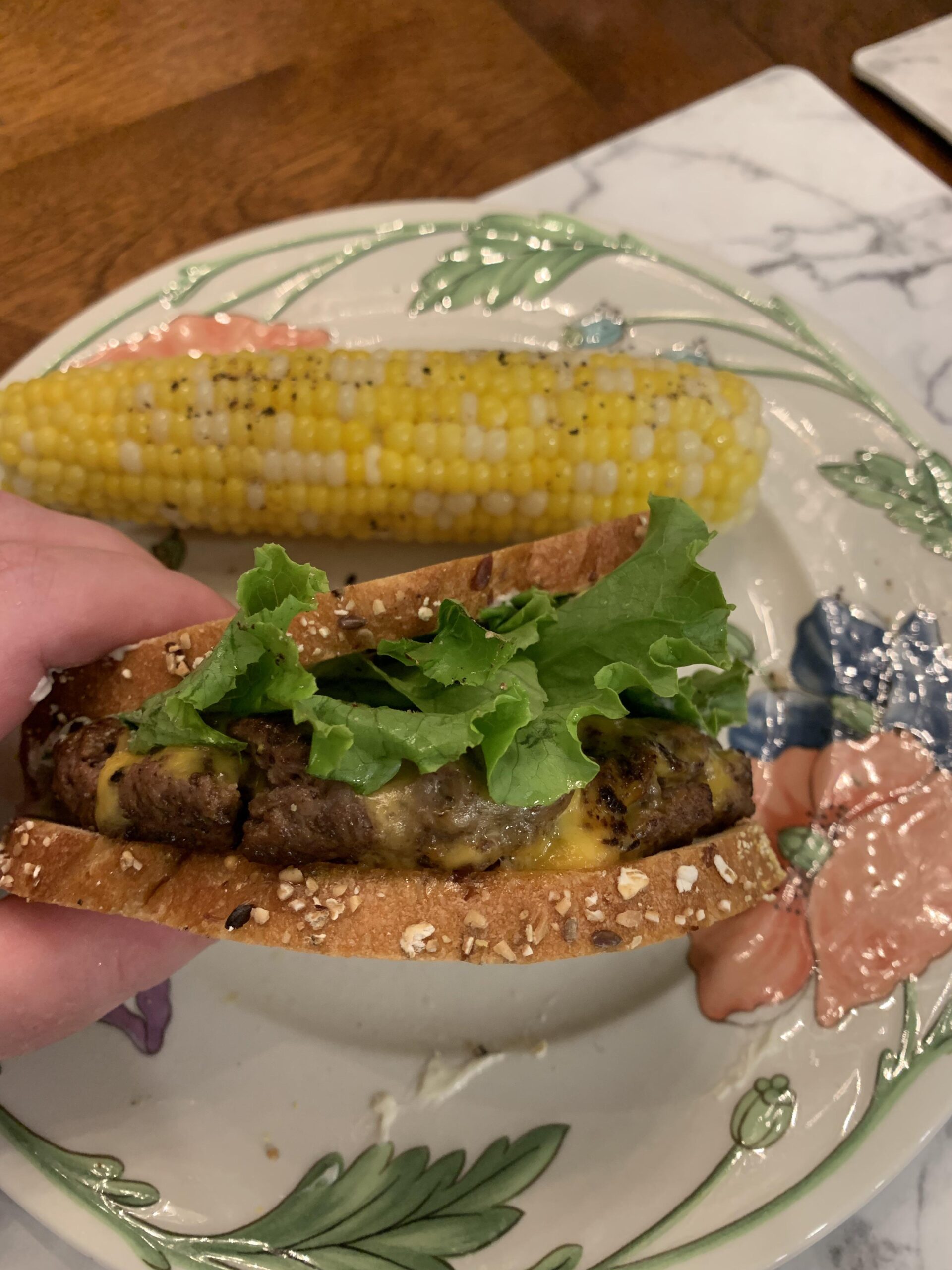 White bread, angus beef, green leaf lettuce, white onion. Oh, and corn ...