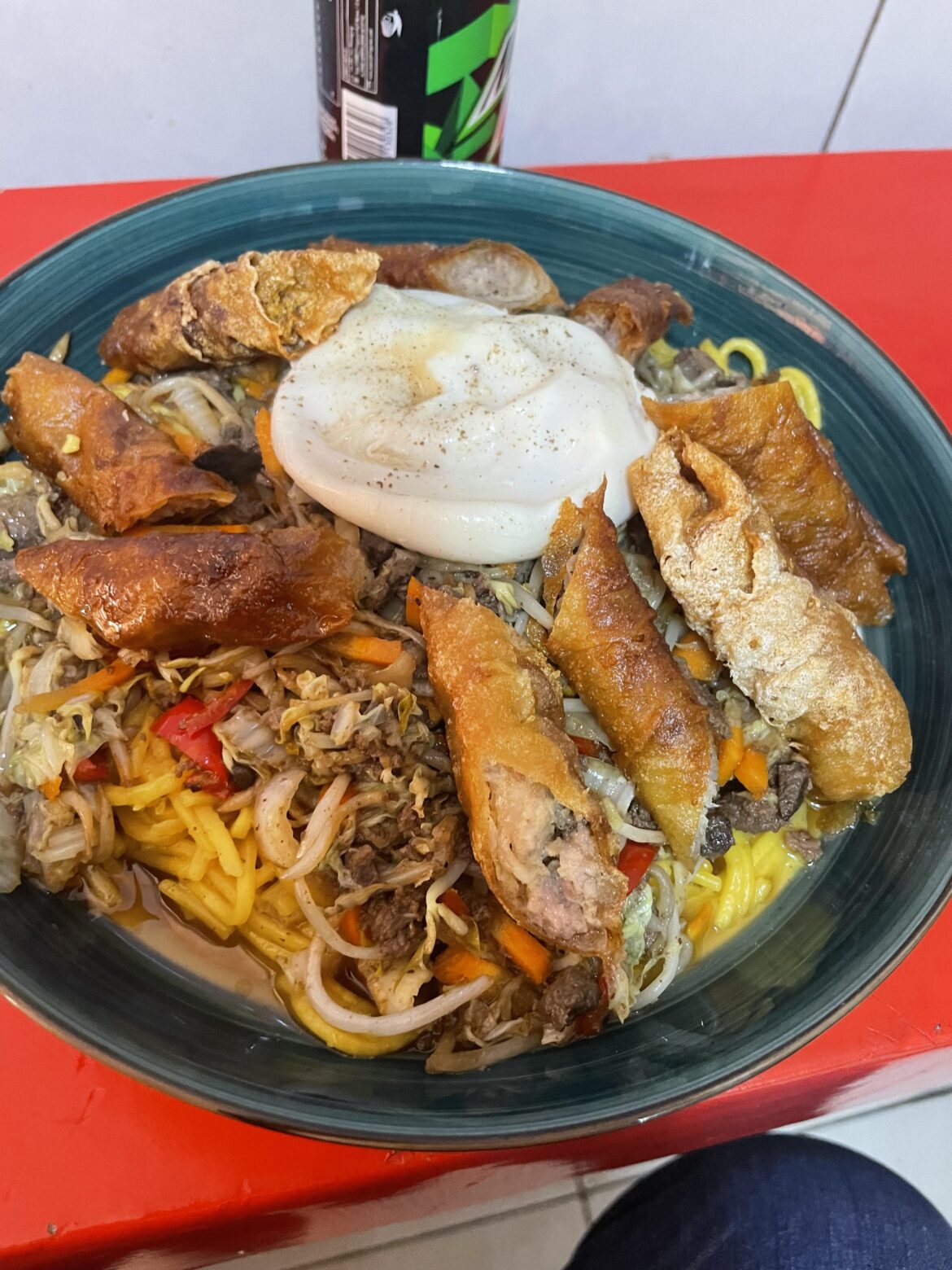 Pancit batil patong (Sauteed noodles with sunny side up egg and meat ...