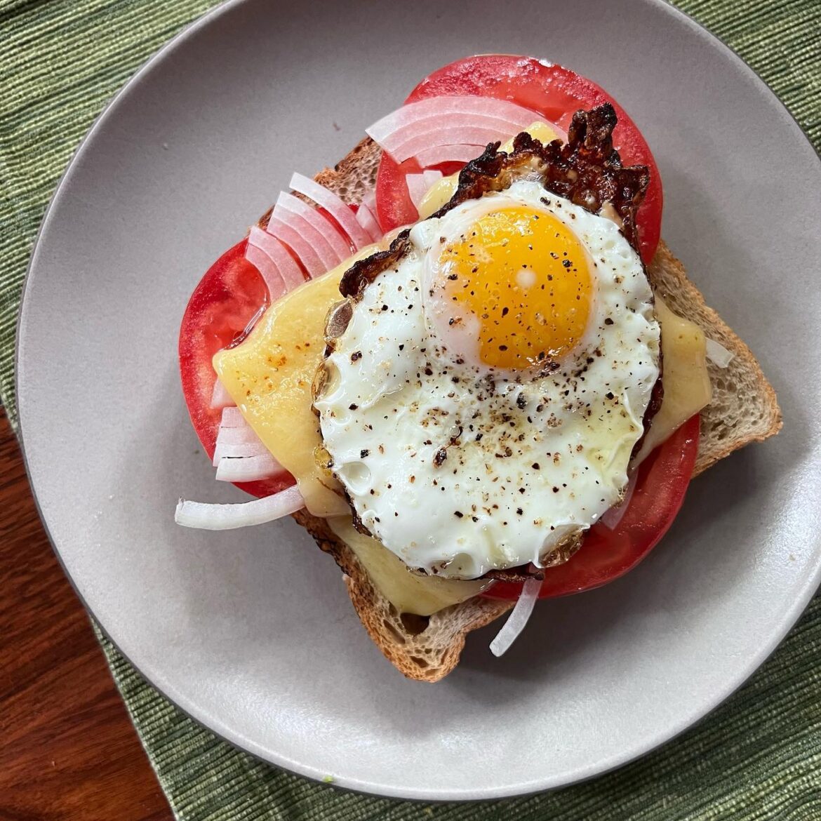 Sourdough toast topped with ripe tomato, a sprinkle of sea salt, sweet ...