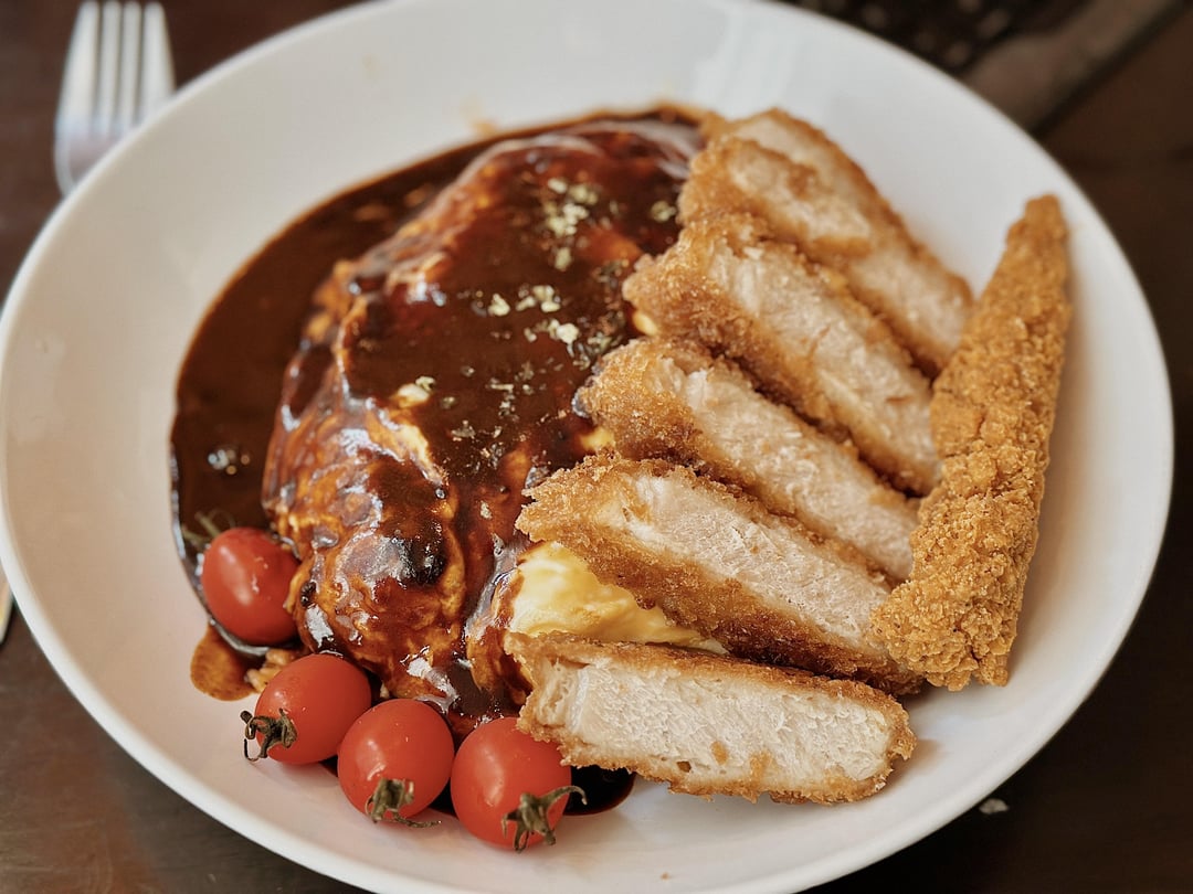 I made Japanese “omurice”. Slabs of roast pork katsu on a bed of ...