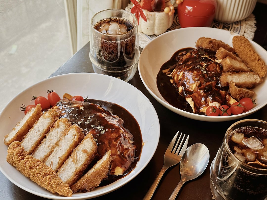 I made Japanese “omurice”. Slabs of roast pork katsu on a bed of ...