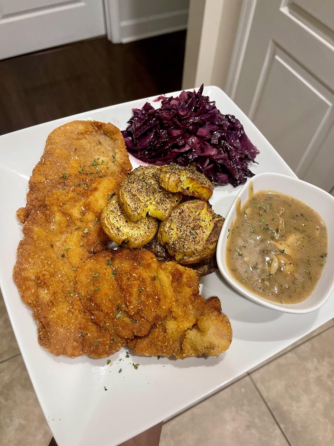 Schnitzel with braised purple cabbage, smashed crispy garlic potatoes ...
