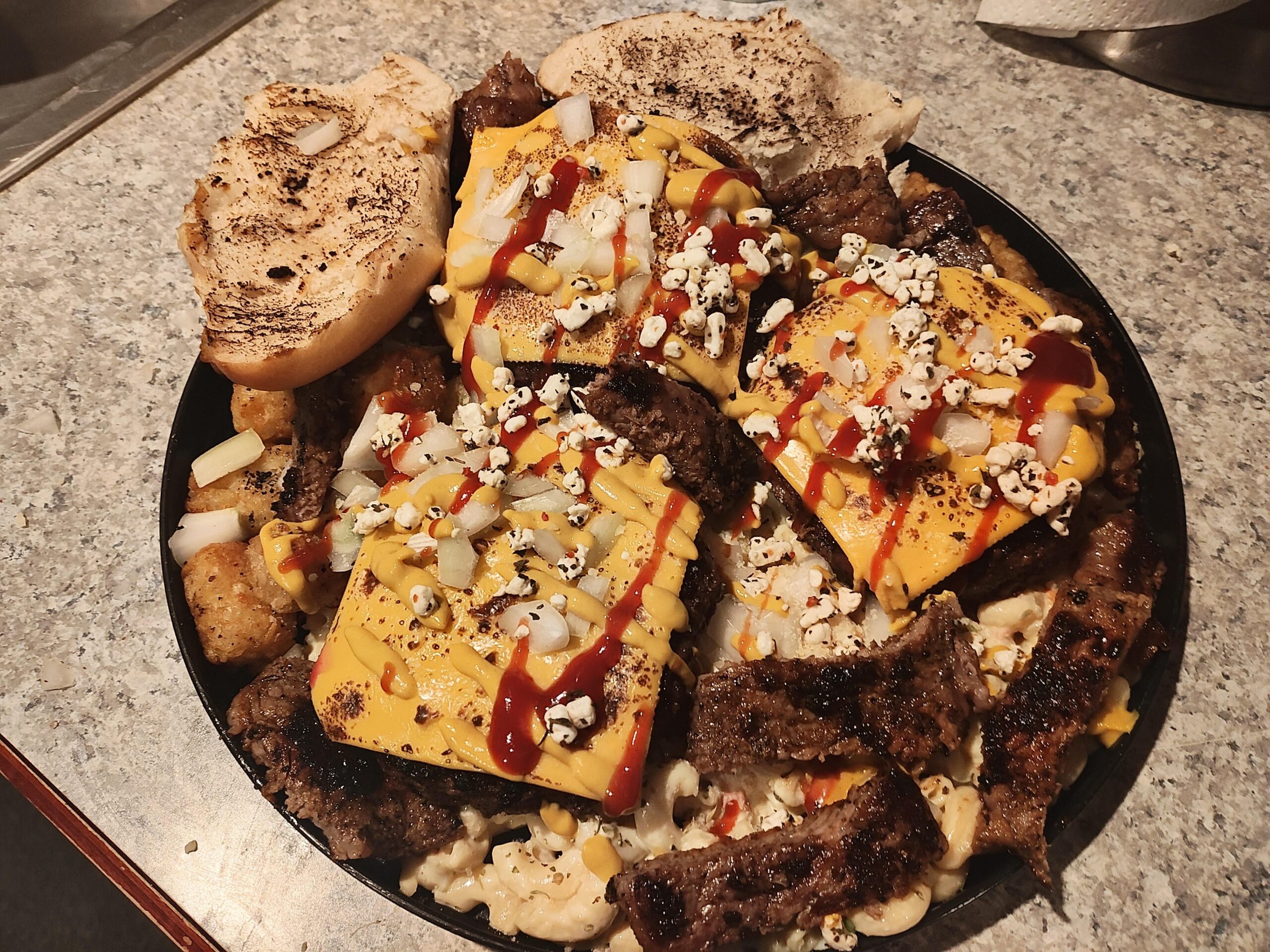 Meat mountain on top of some tots and macaroni salad - Dining and Cooking