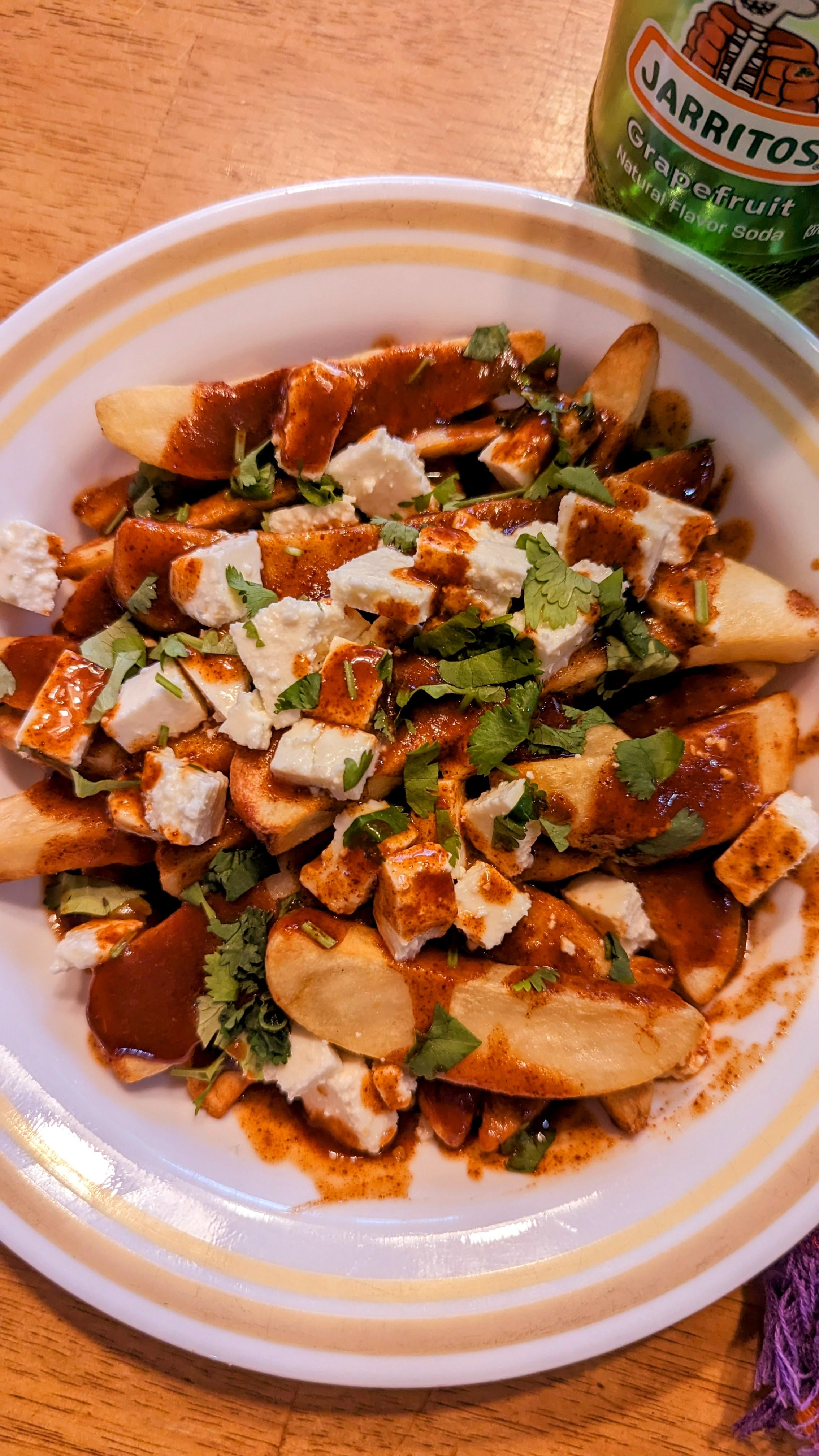 Papas fritas con chile colorado y queso fresco served in a Poutine ...