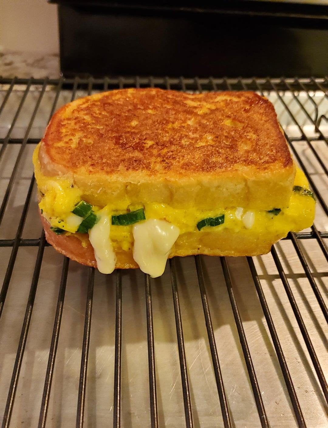 Making a egg toast sandwich with smoked ham and American cheese on ...
