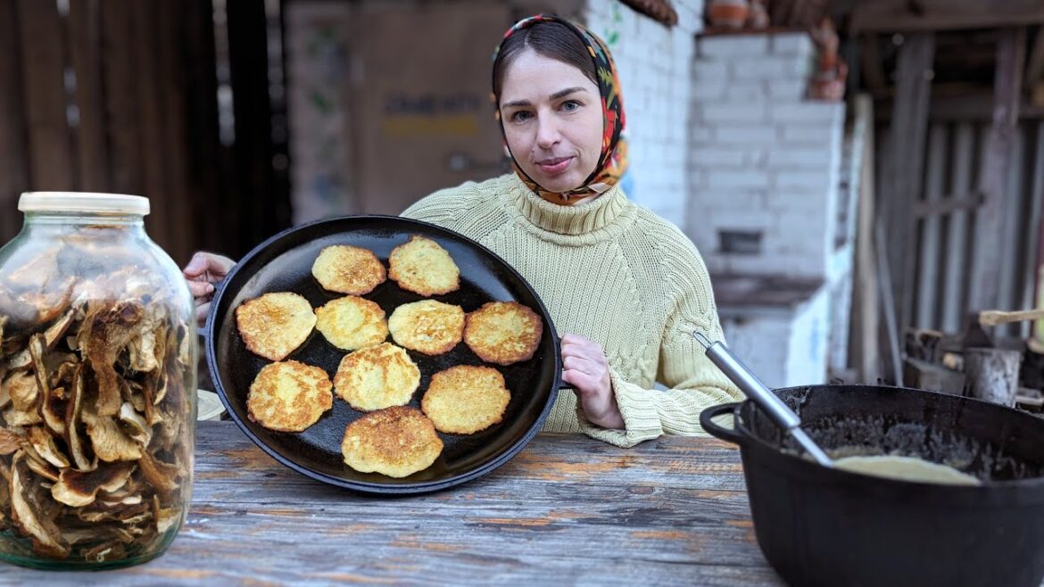 Village life. Woman is cooking her best potato pancakes. Mountain dried ...