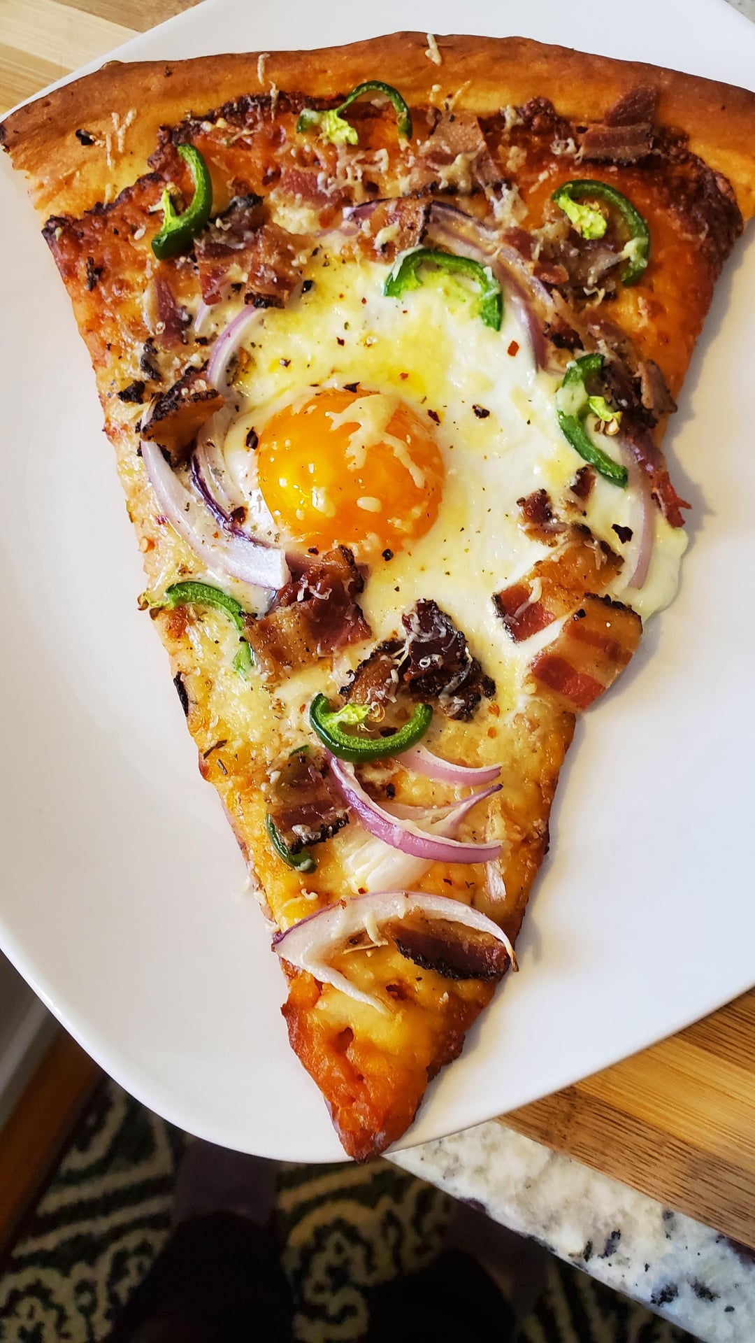 Transfered cold pizza to a breakfast pizza by adding egg, bacon ...