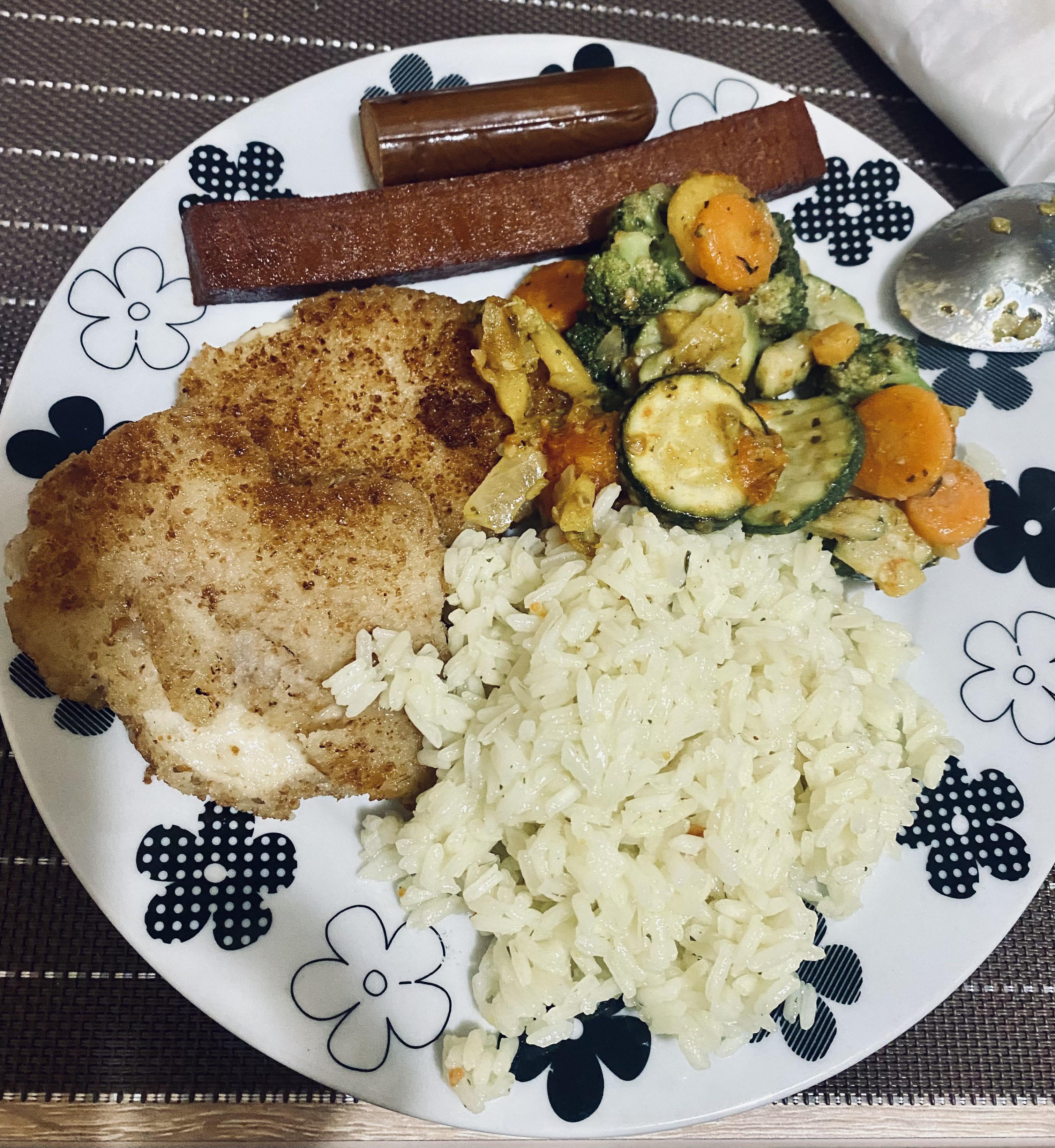 schnitzel, sausage snacks, roasted veggies and rice with vegeta ...