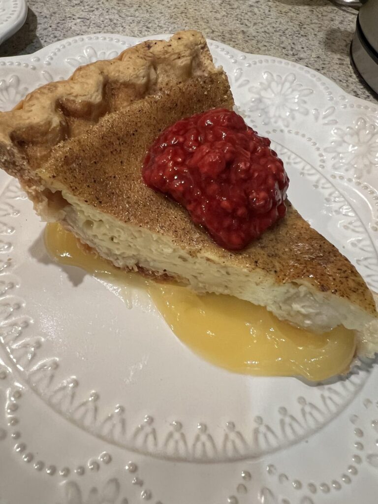 Homemade custard pie with lemon curd below and raspberry topping ...