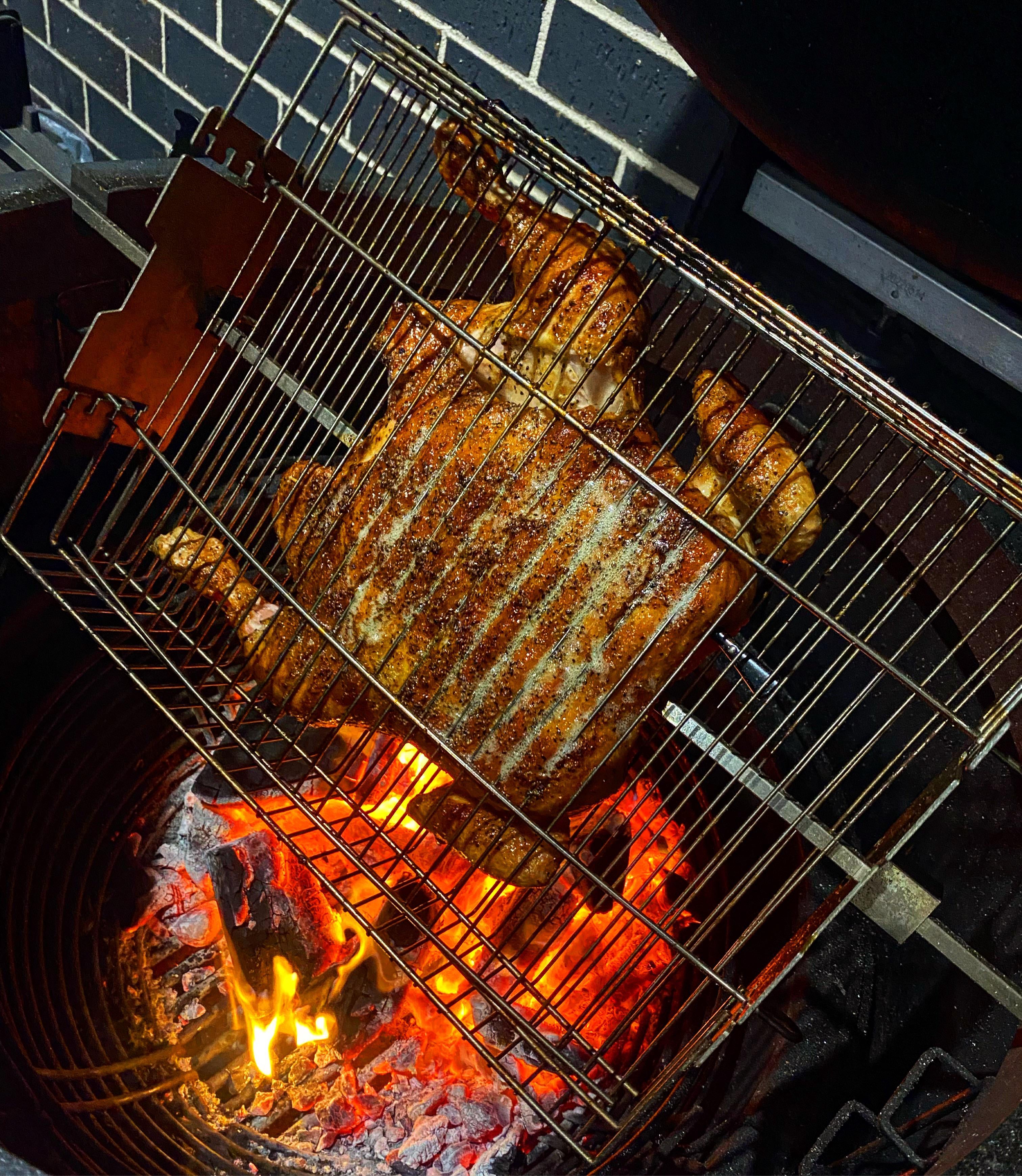 Spatchcocked chicken on the Joetisserie cooked over direct heat on a ...