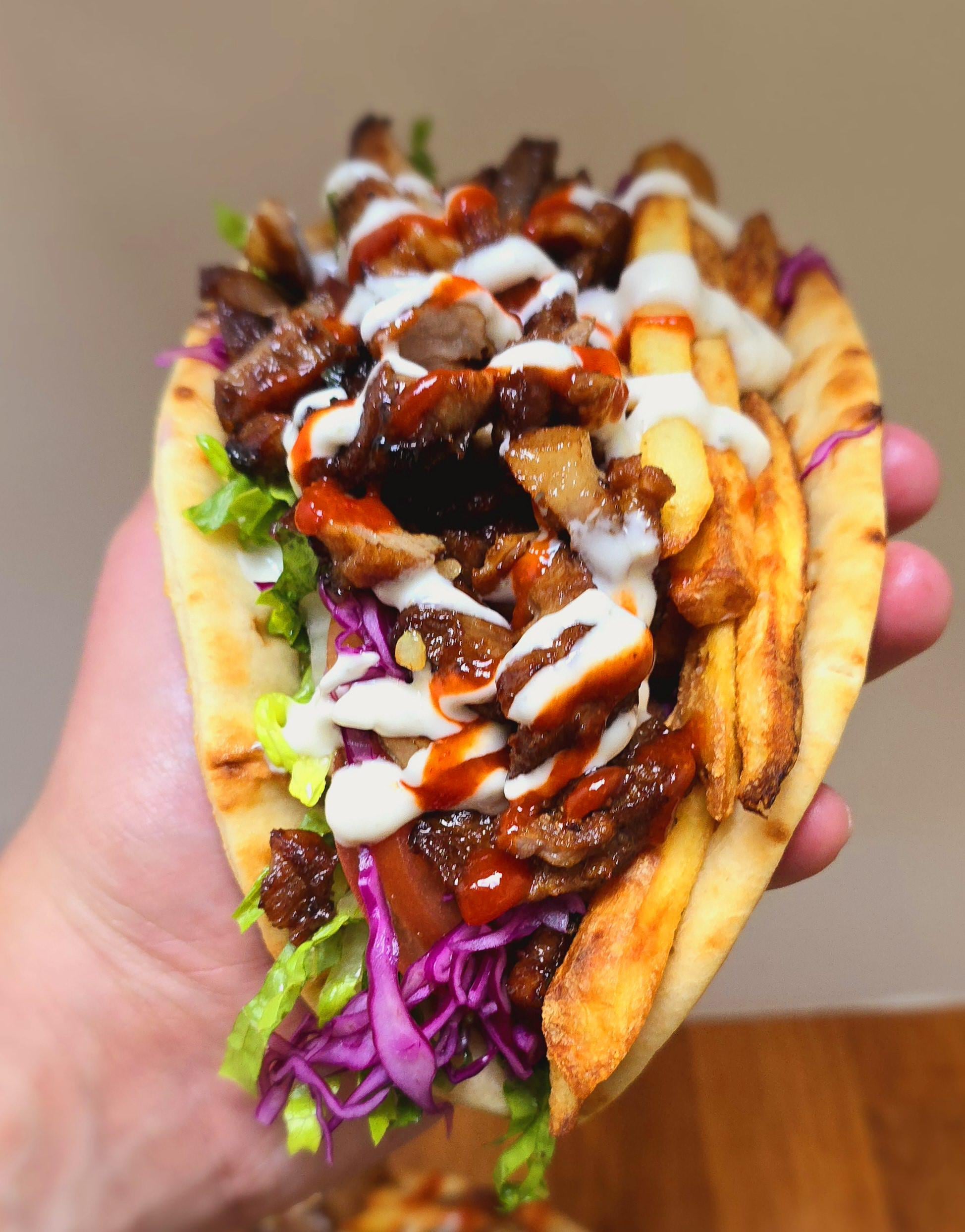 Pork Gyros, with garlic sauce, harissa drizzle, and all the salad ...