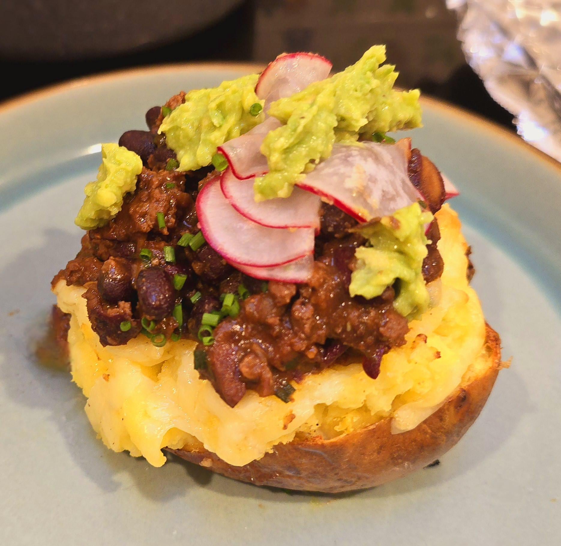 Loaded jacket potato skins, three bean chilli, pickled radishes and ...