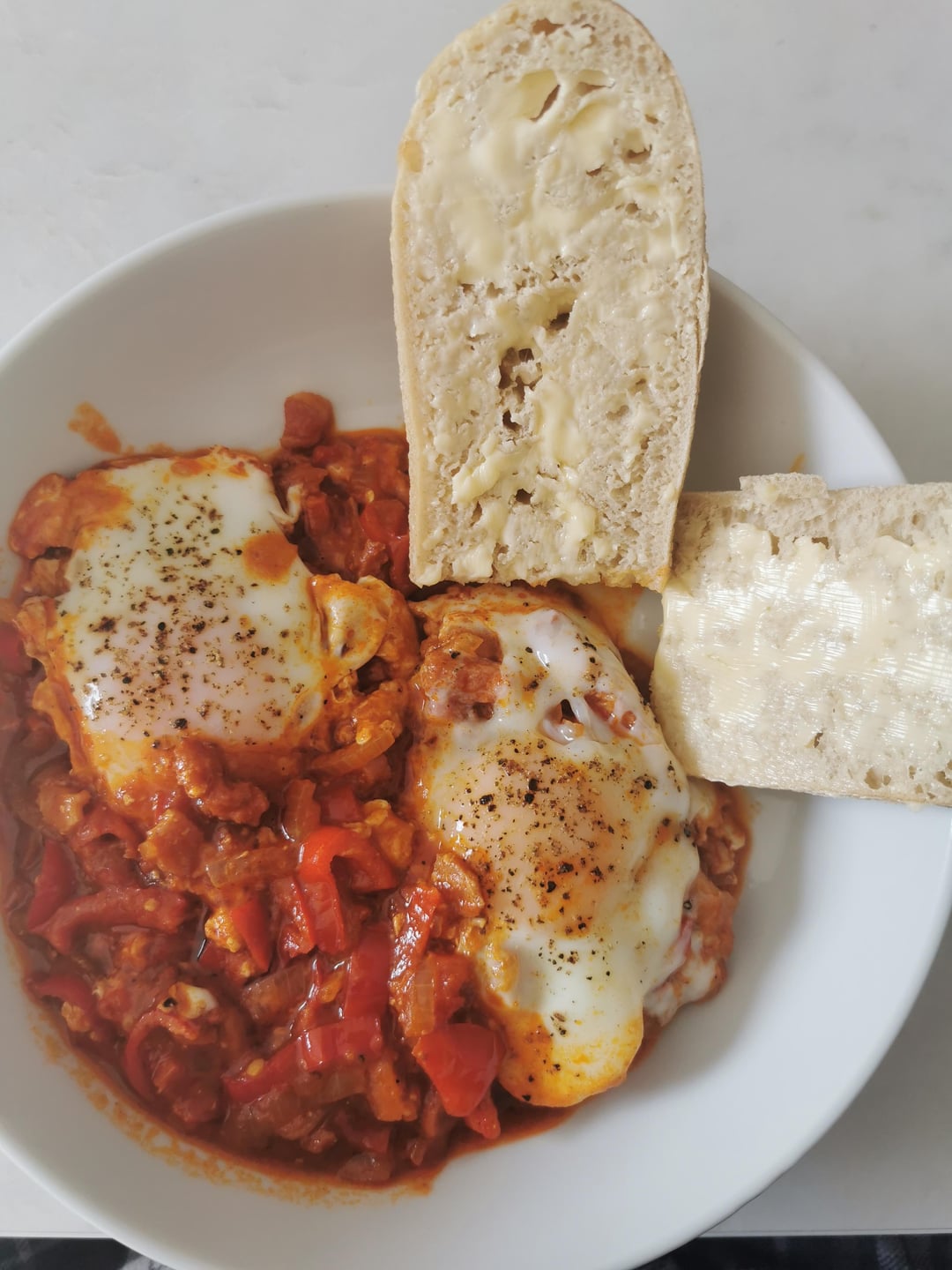 Shakshuka with poached eggs and sourdough bread. - Dining and Cooking