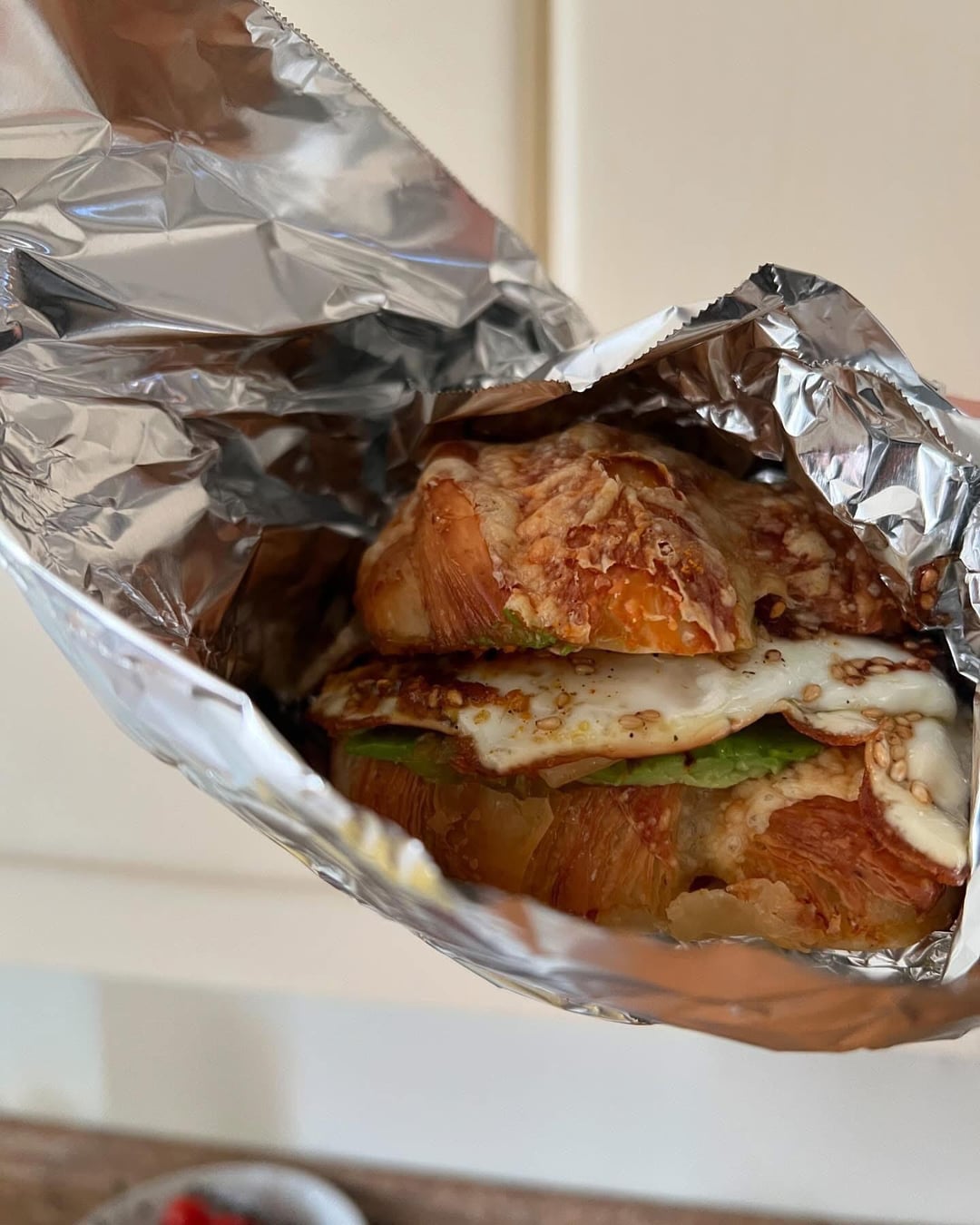 Ham and cheese croissant, avocado, fried egg, midnight moon goat cheese ...