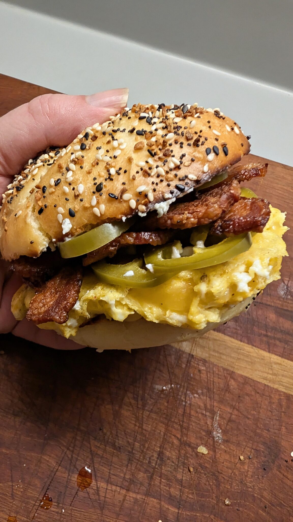 Eggs, bacon, Gouda cheese, pickled jalapenos on an everything kaiser ...