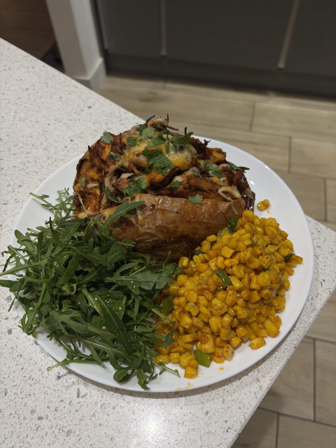 Jacket Potato with BBQ Chicken, charred garlic corn and rocket - Dining ...